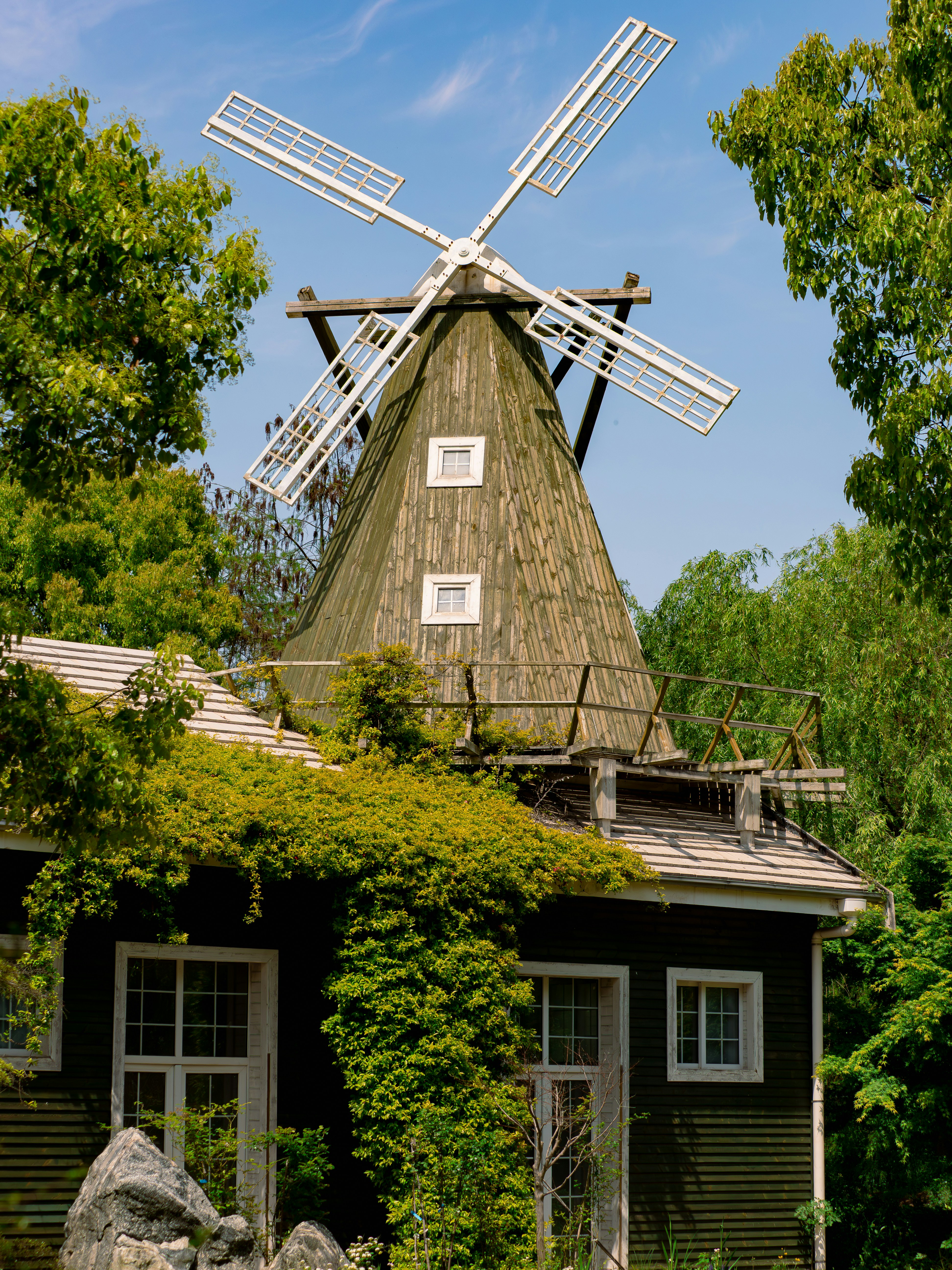 Old Windmill Overlooking a Sunlit Cottage Garden
