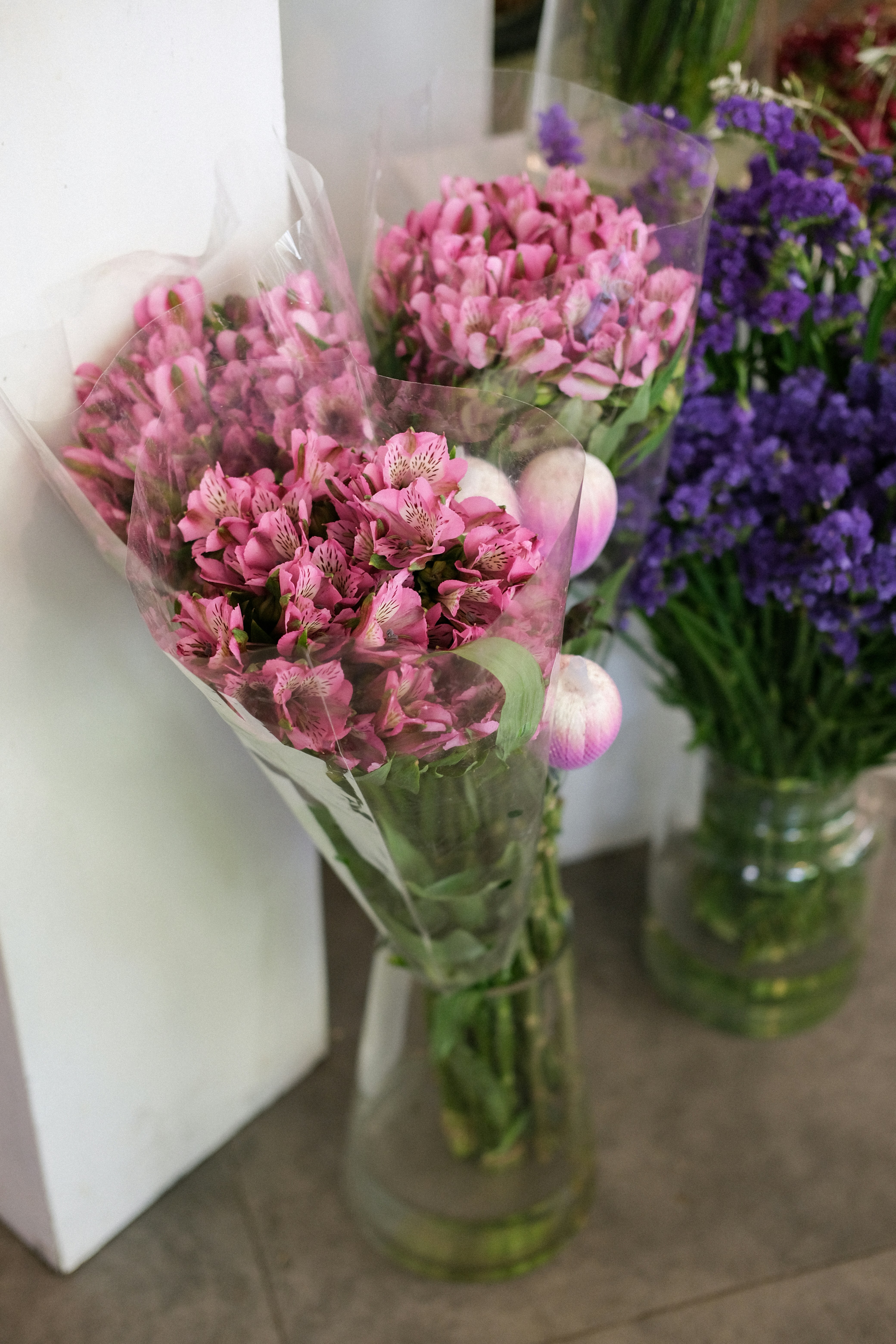 Pink Hydrangea Bouquets in Clear Wrapping with Purple Arrangement