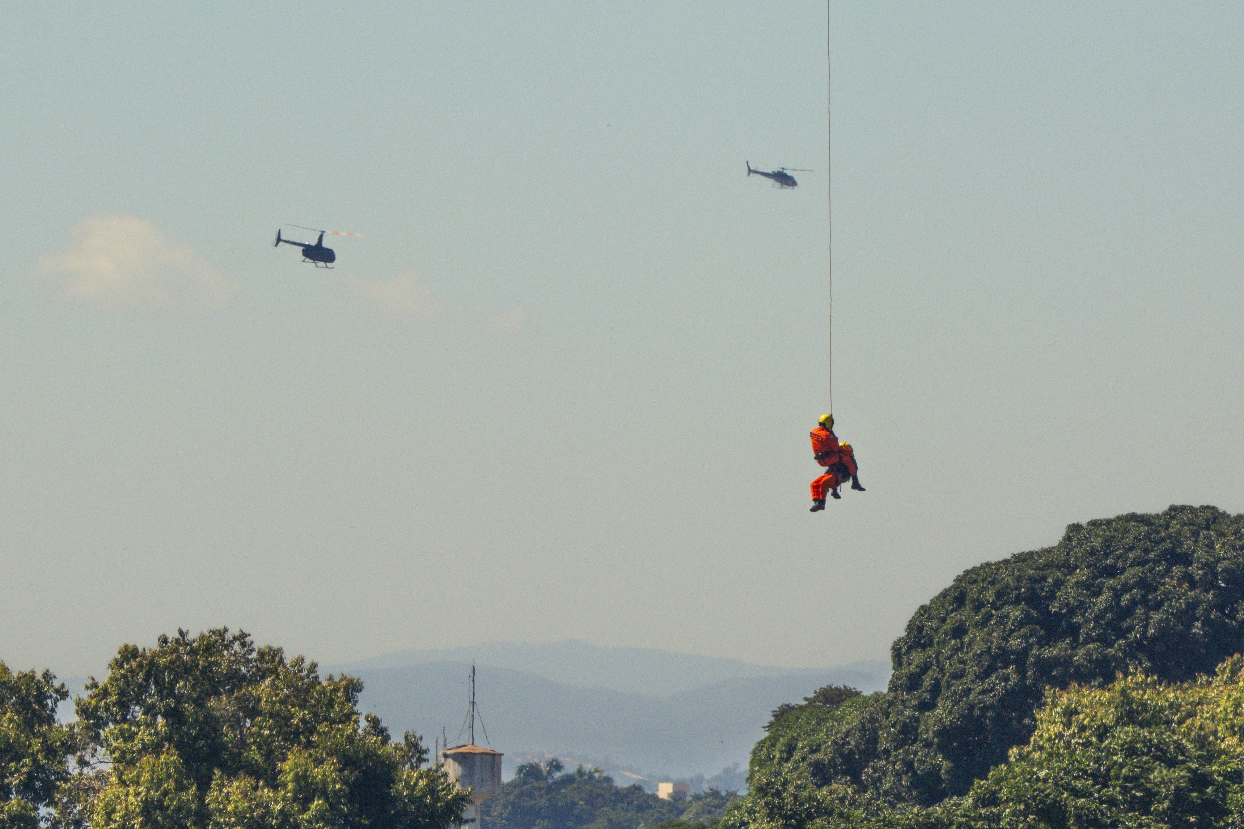Aerial Rescue: Rappelling Climber Dangled Against a Quiet Skyline