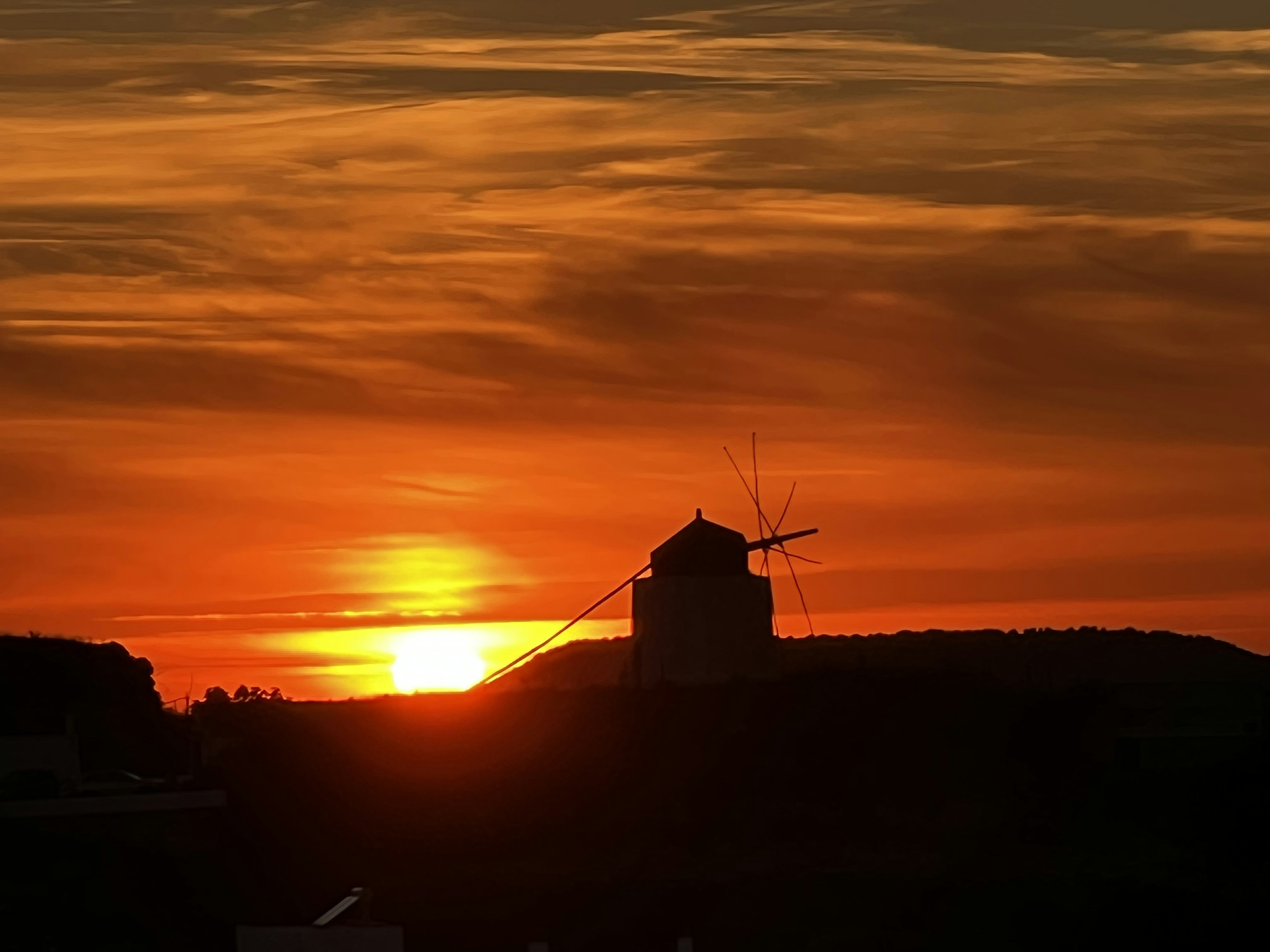 Silhouette of a Windmill at Sunset