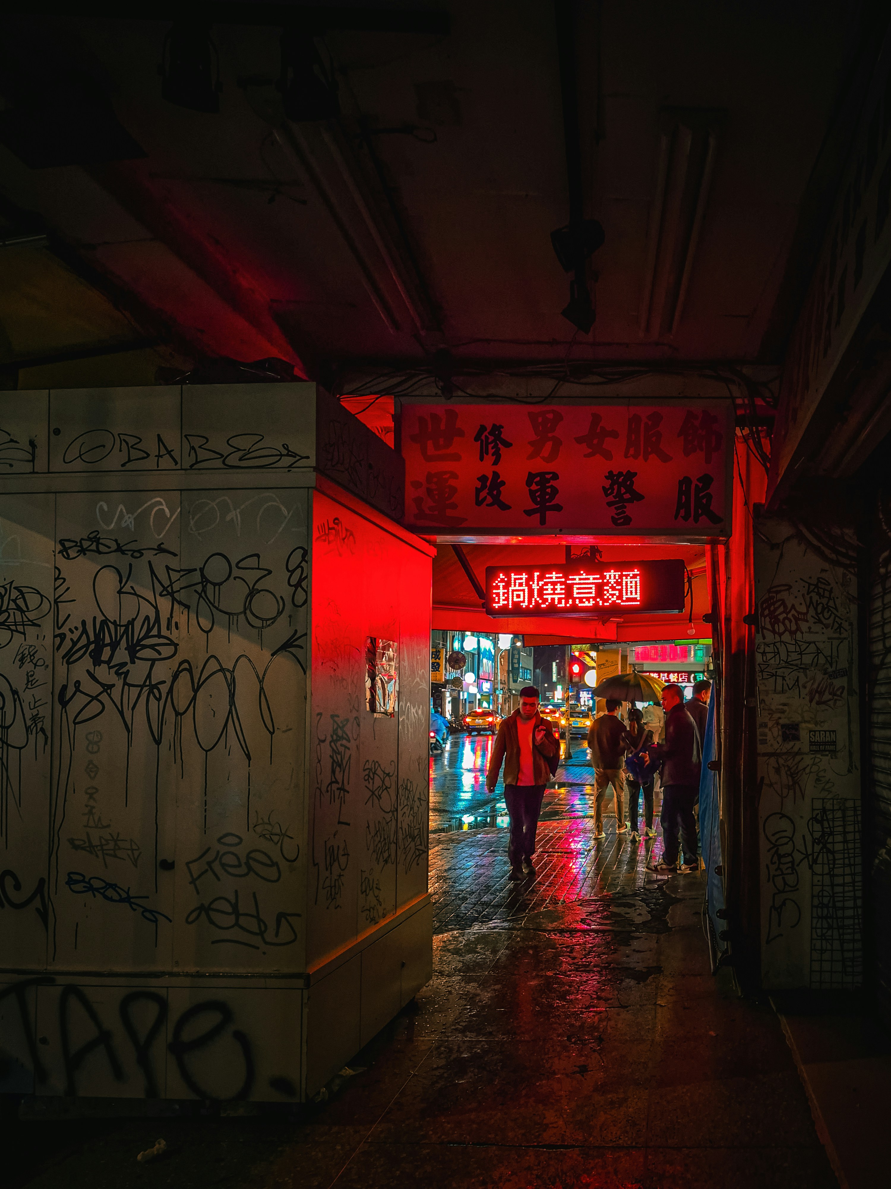 Neon Corridor Under Red Signs
