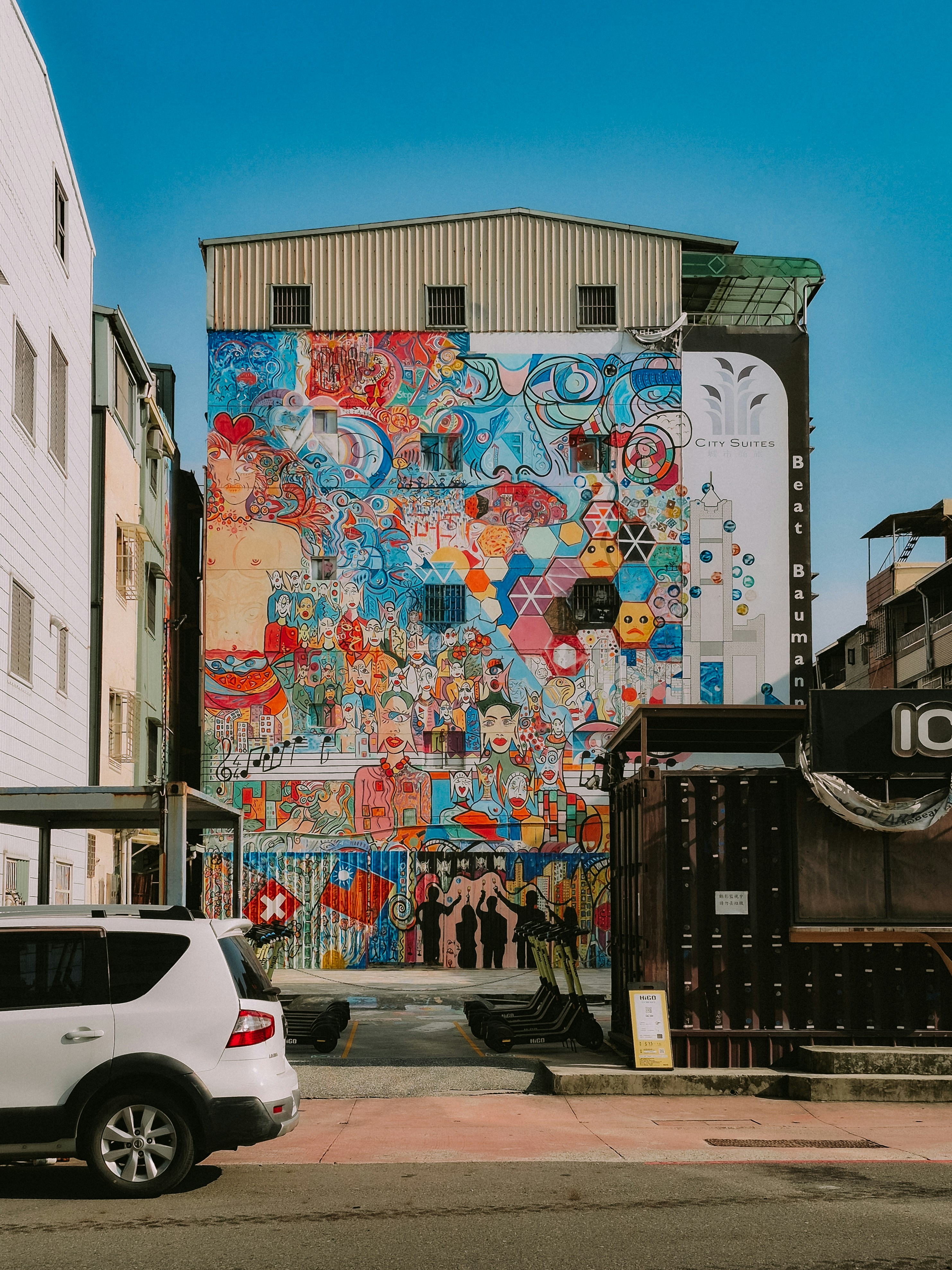 Vibrant City Mural: A Kaleidoscope of Shapes and Faces
