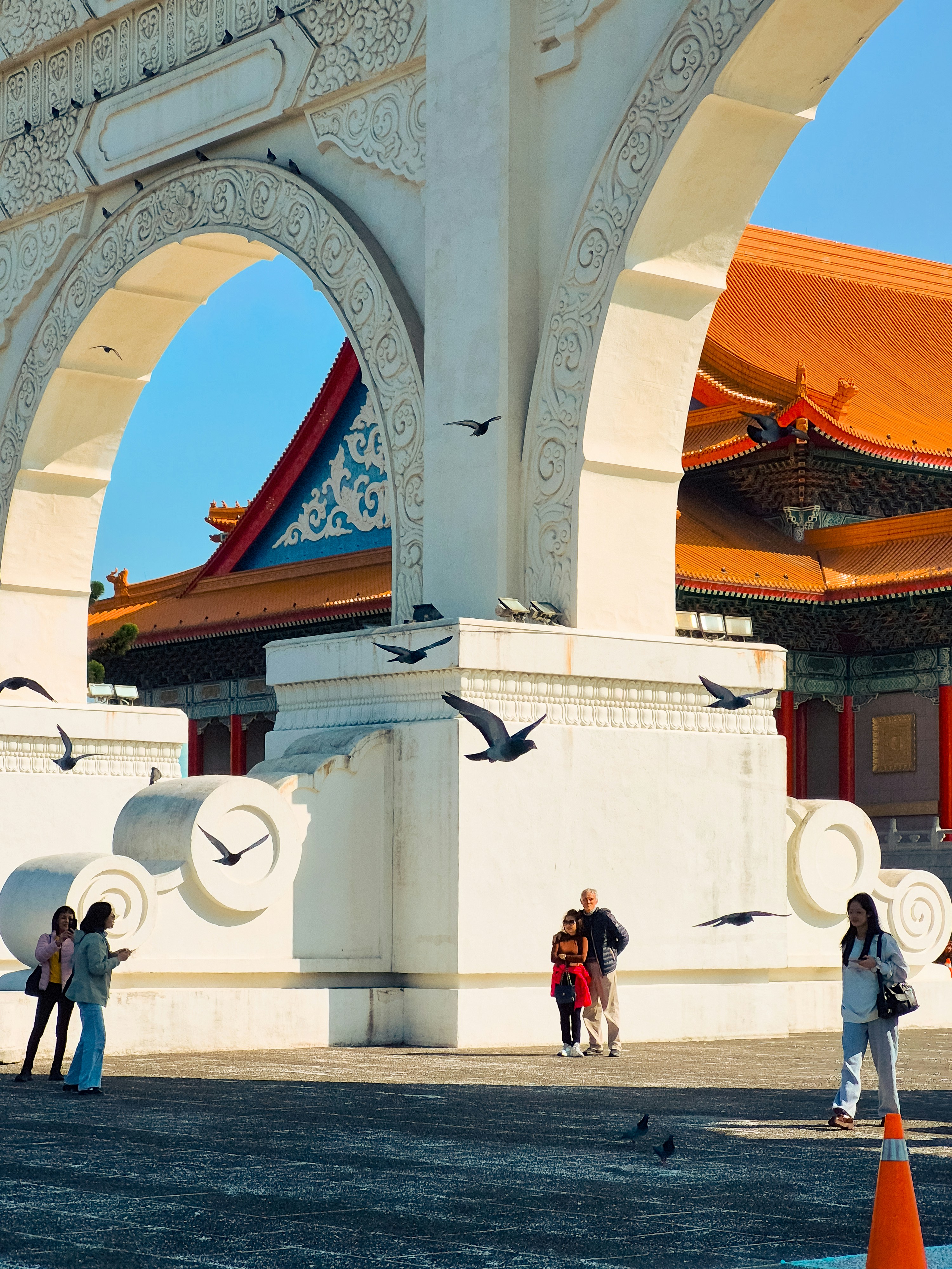 Archway Majesty: Pigeons in Flight Over a Temple Courtyard