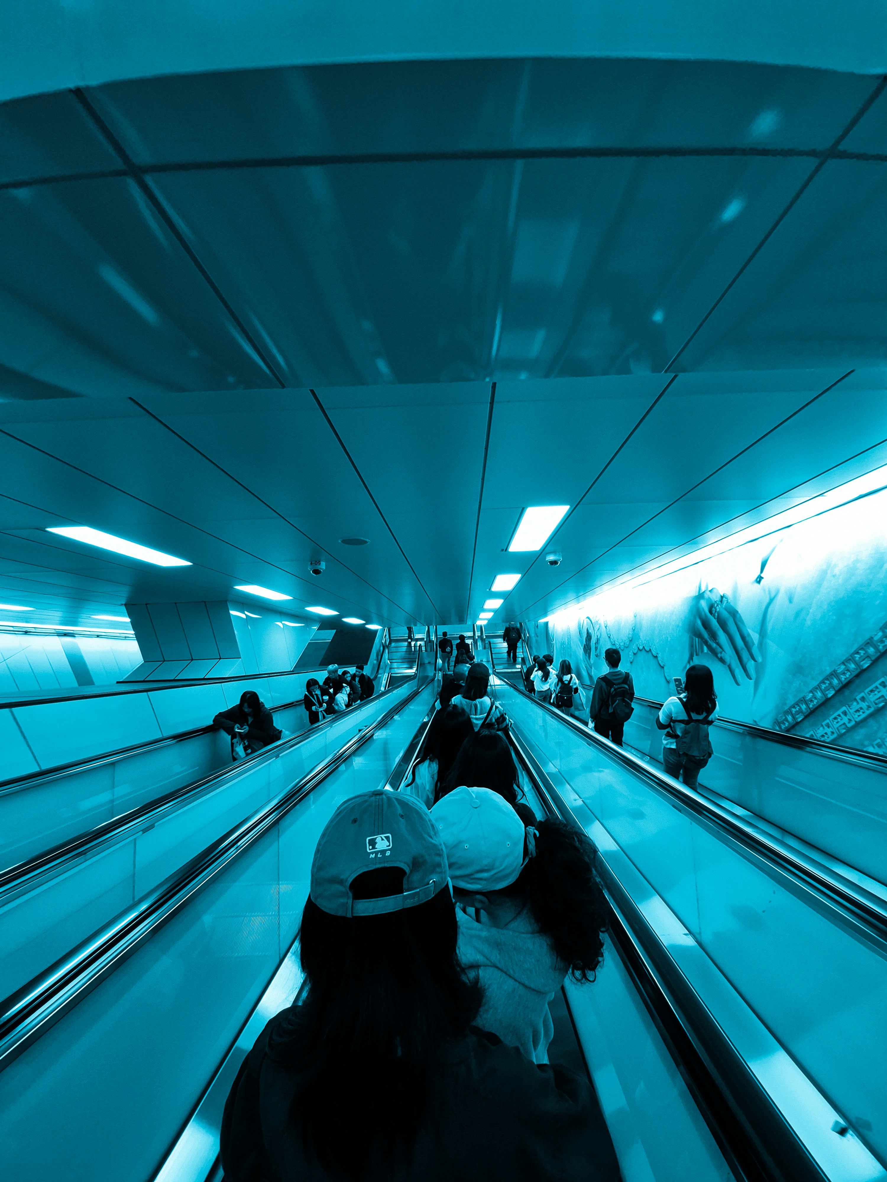 Tunnel of People: A Blue Hour Ascent in an Underground Corridor