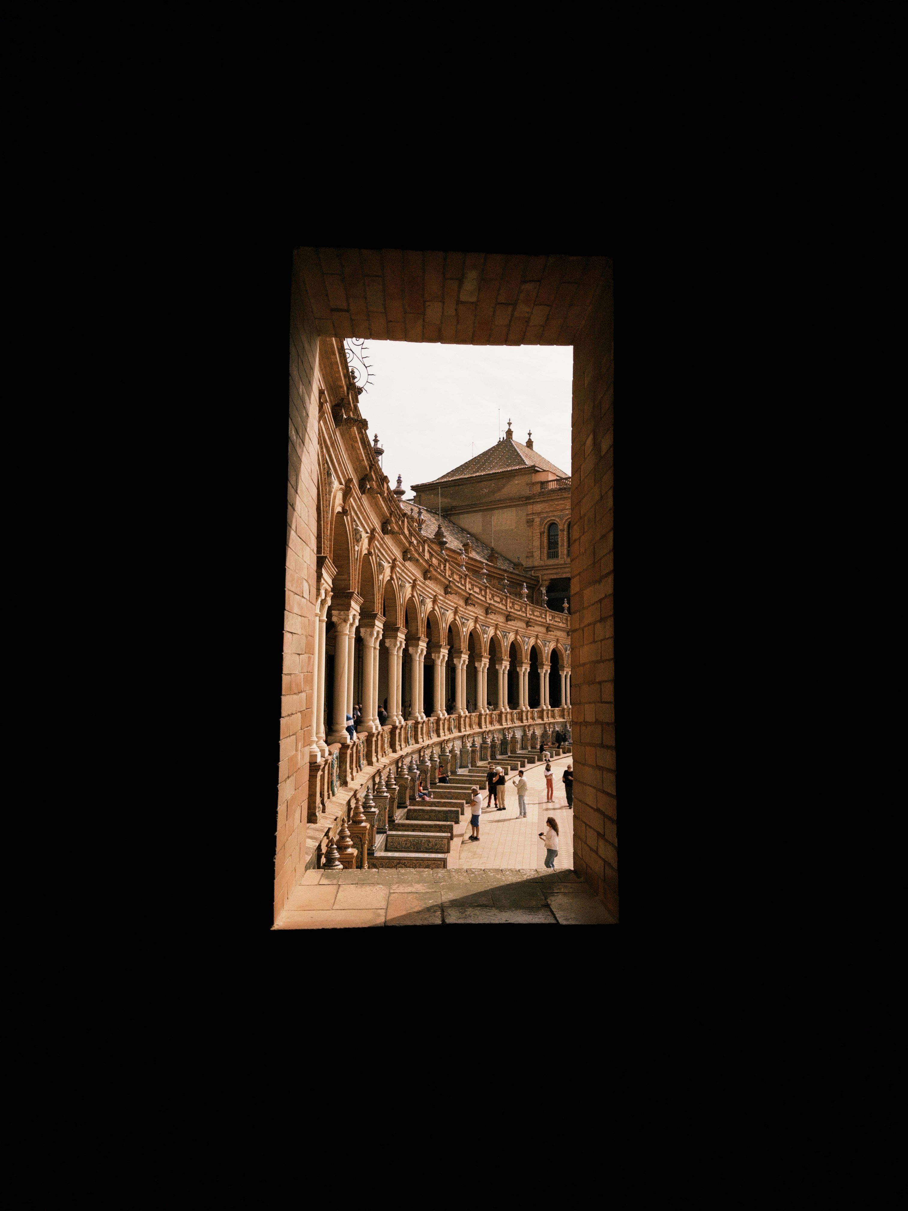 Archway Corridor Framed by a Narrow Window