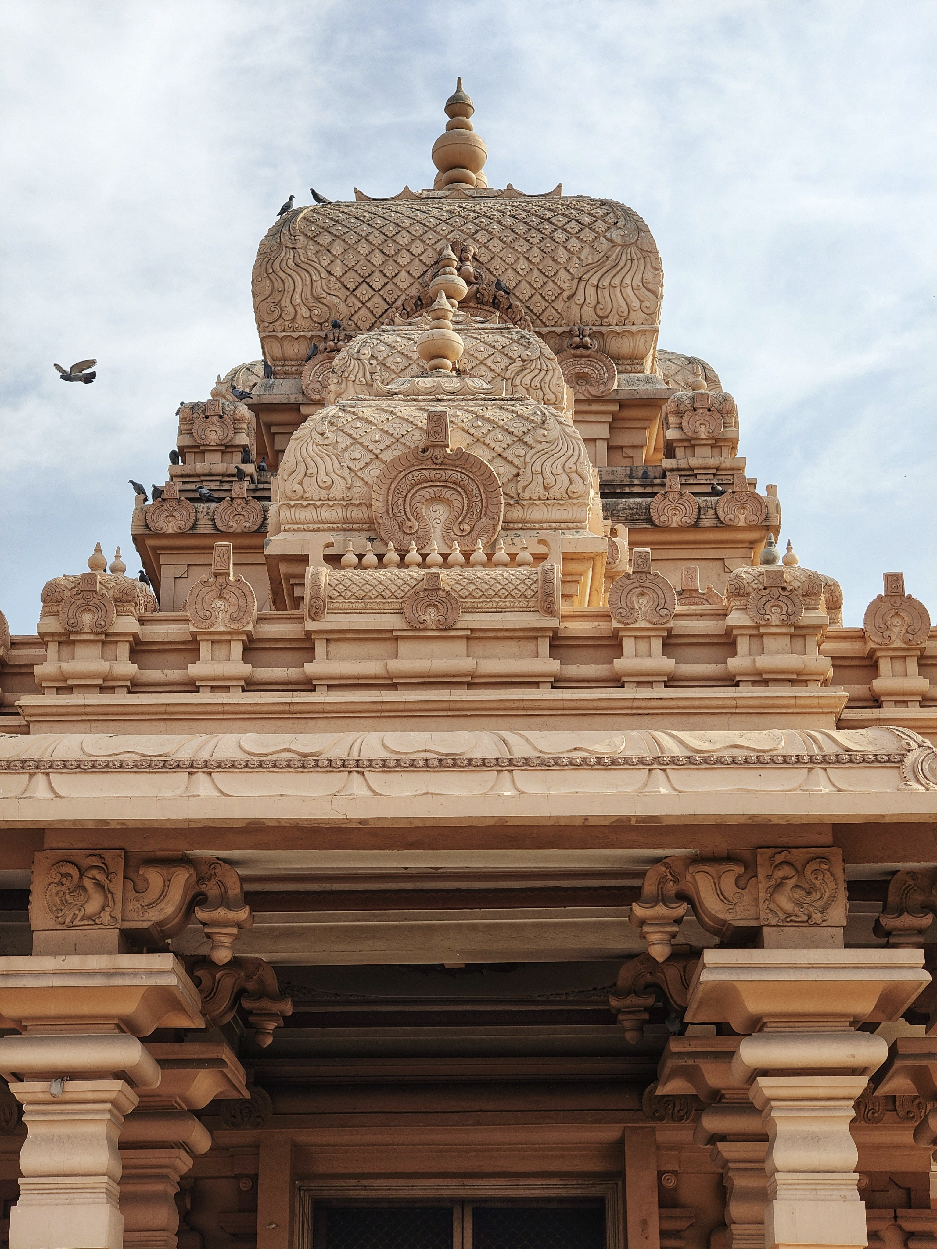 Ornate Temple Crown: Carved Sandstone Tiered Architecture Reaching the Sky