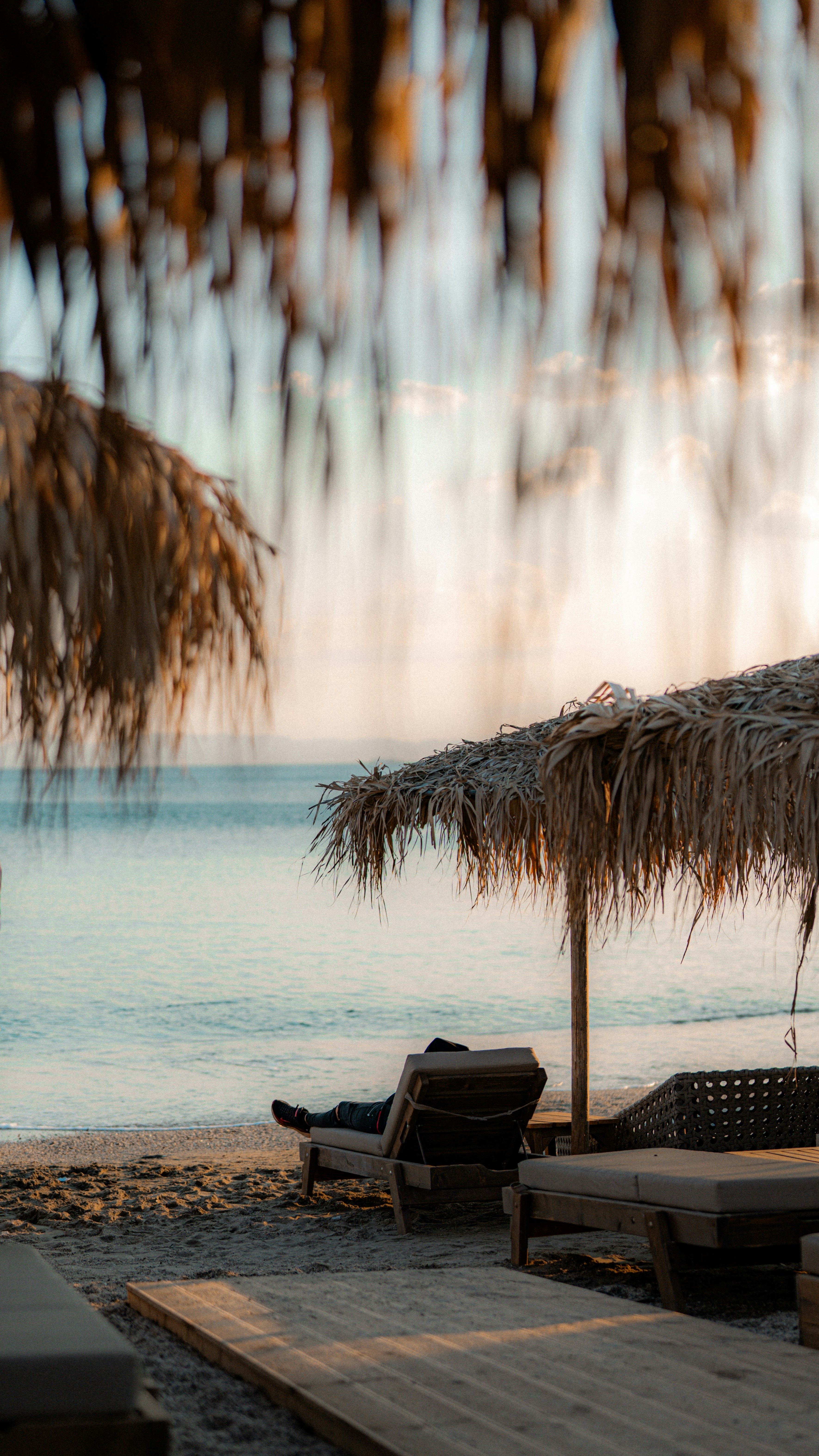Sunlit Beach Chairs Amid Quiet Waters at Dusk