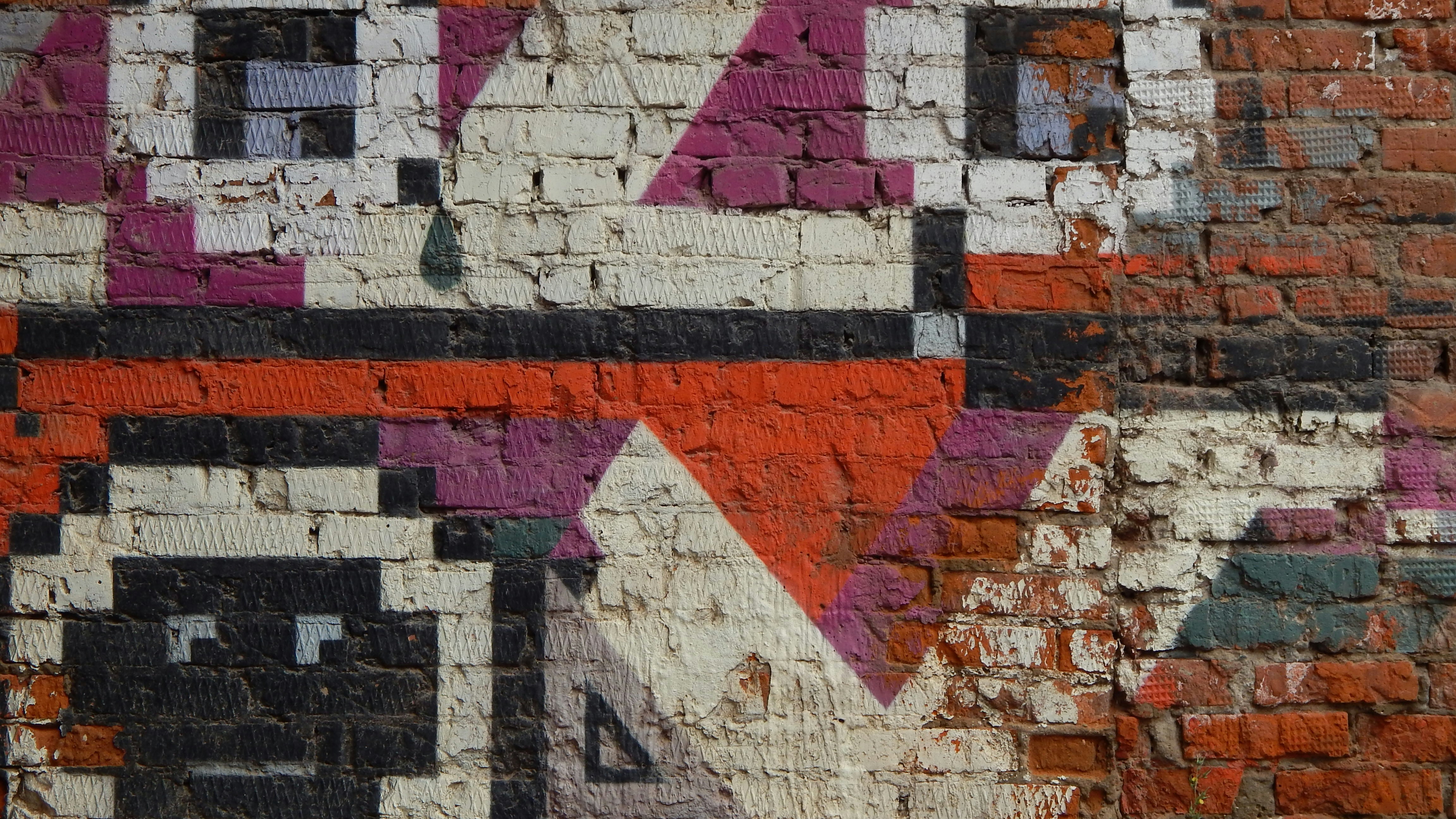 Urban Mosaic: A Fragment of Color on Brick Canvas