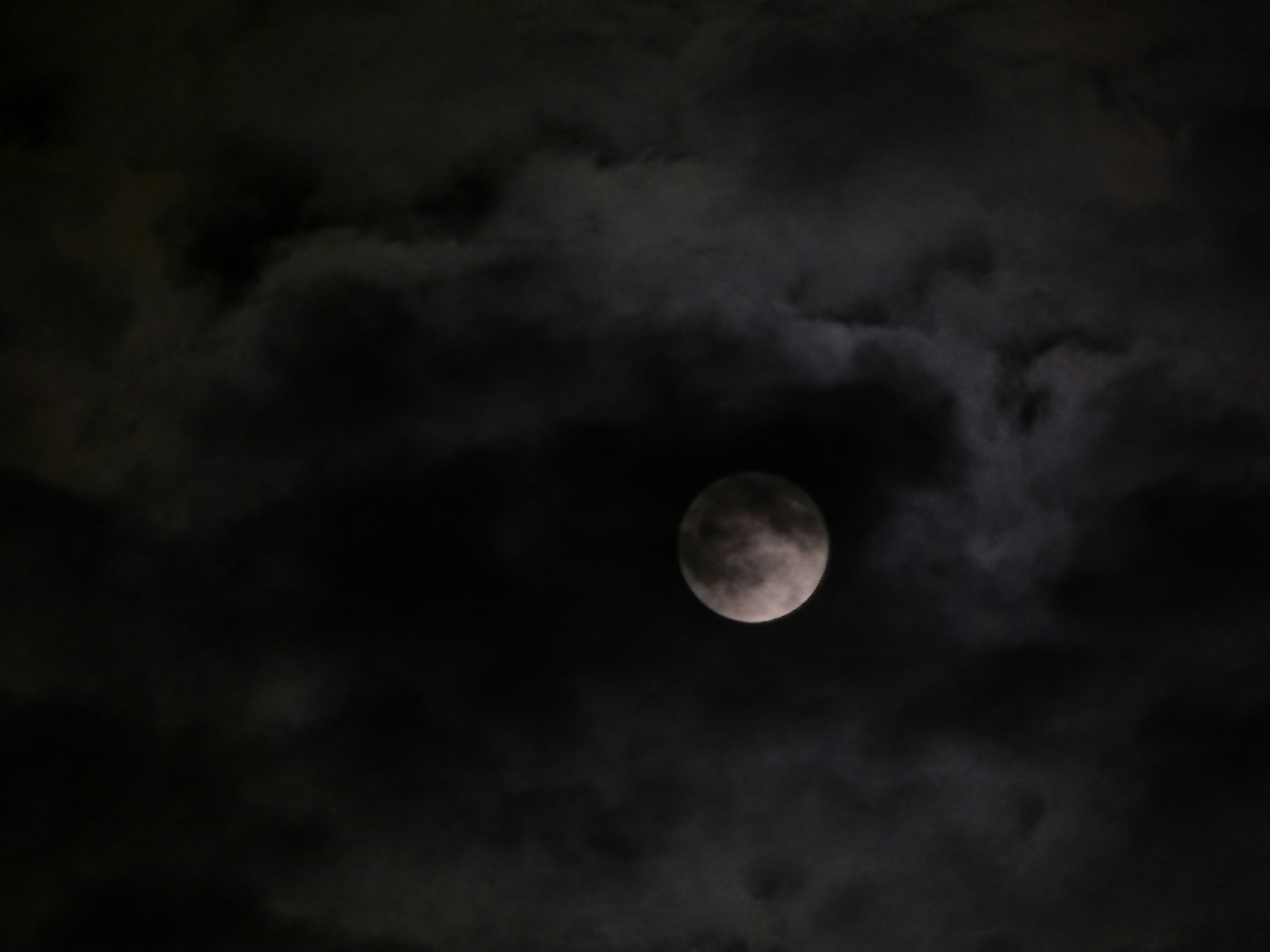 Lunar Spotlight Through Thin Veil of Clouds