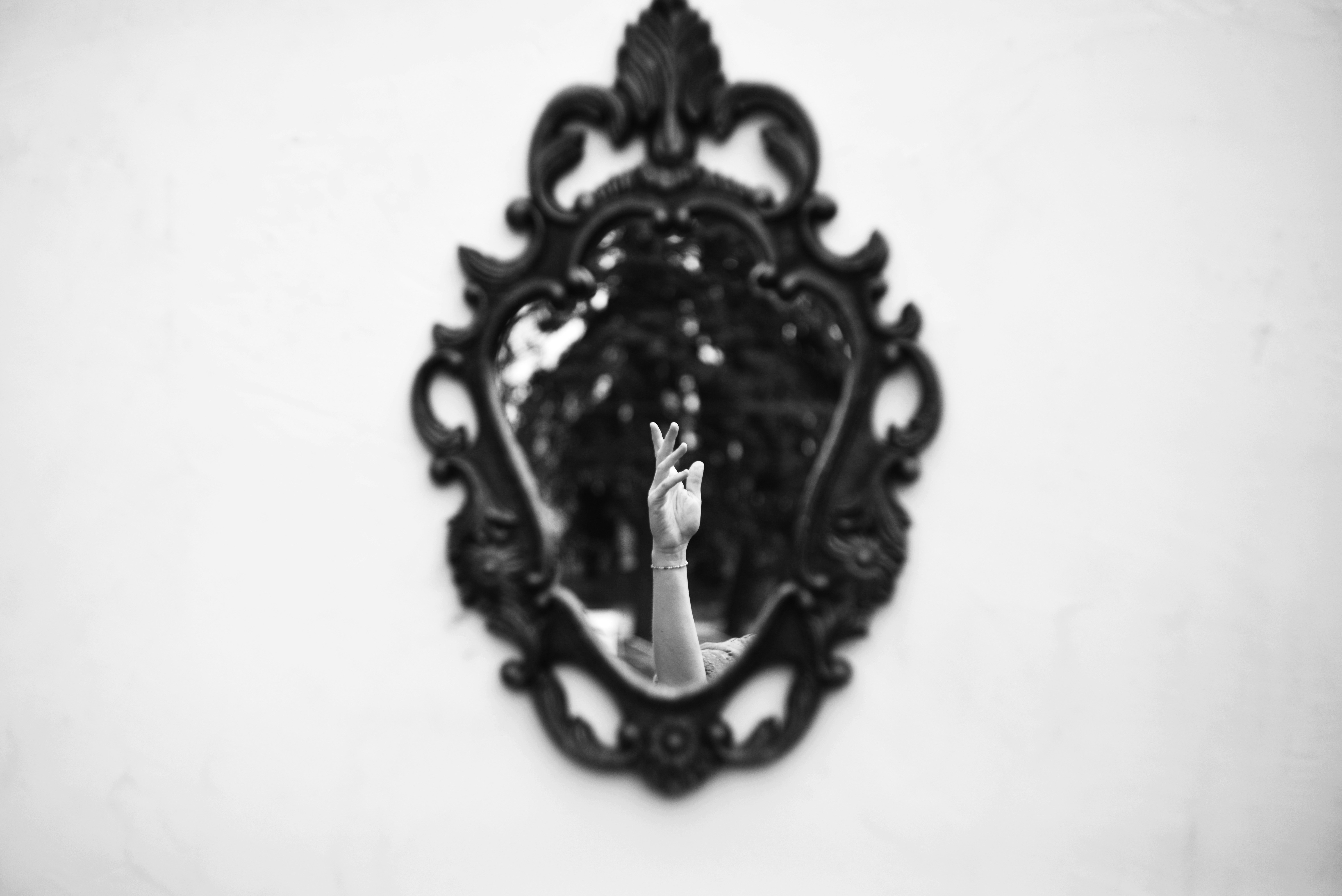 Glimpse in the Mirror: A Hand Reaching Through Darkness