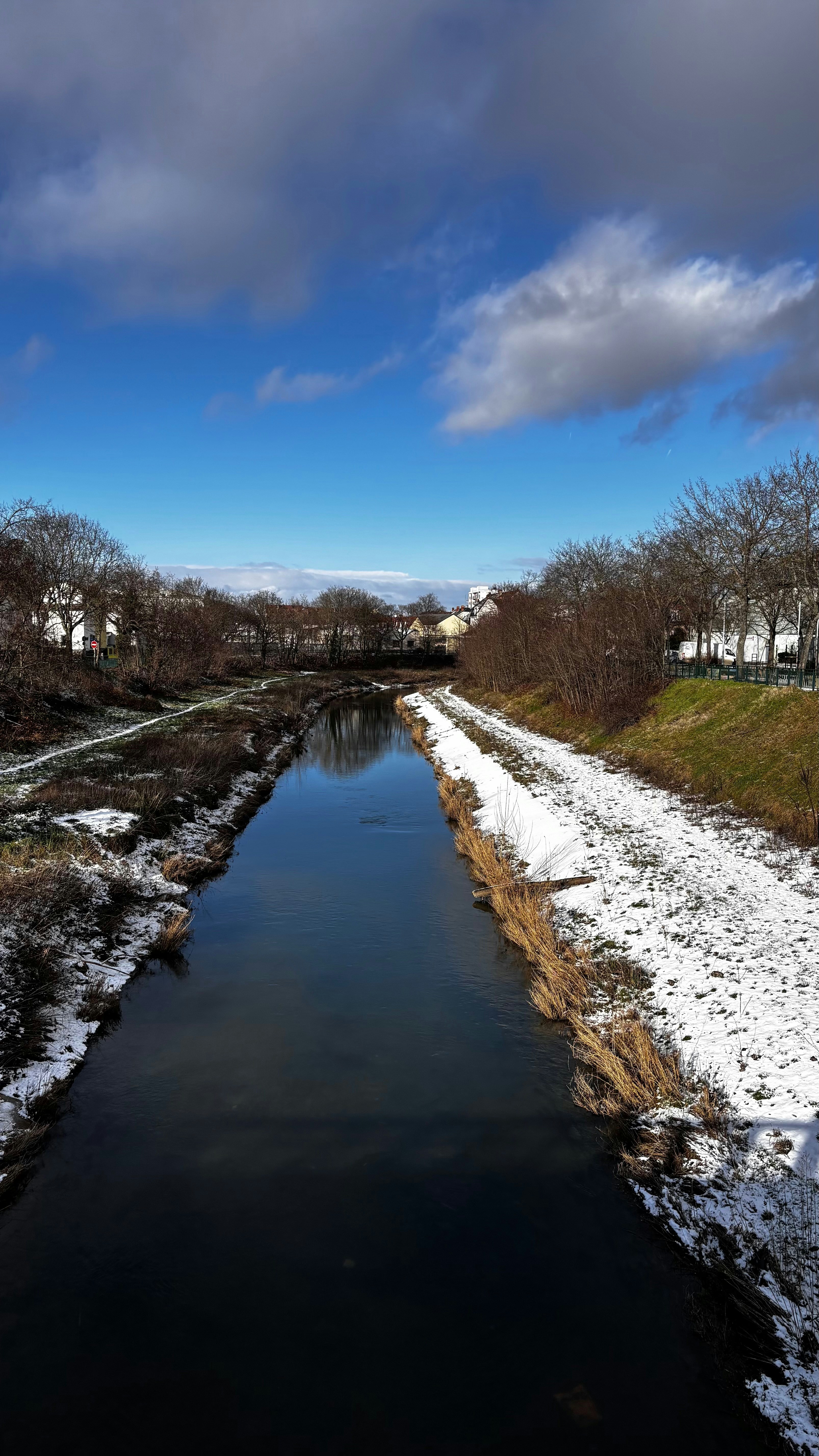 Winter Channel: A Quiet River Meanders Toward the Town