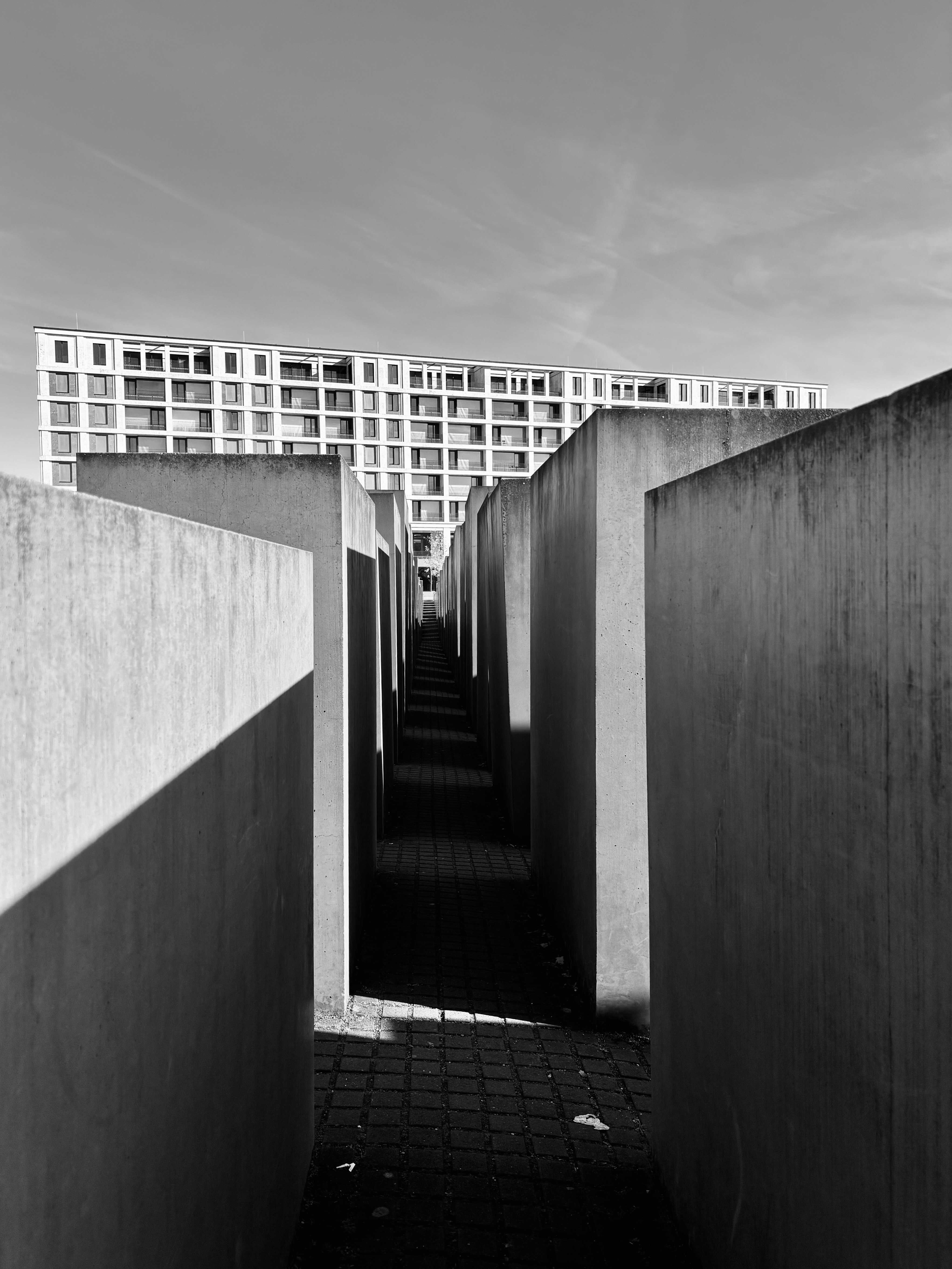 A Corridor of Shadows: Concrete Slabs Receding Toward a Grid
