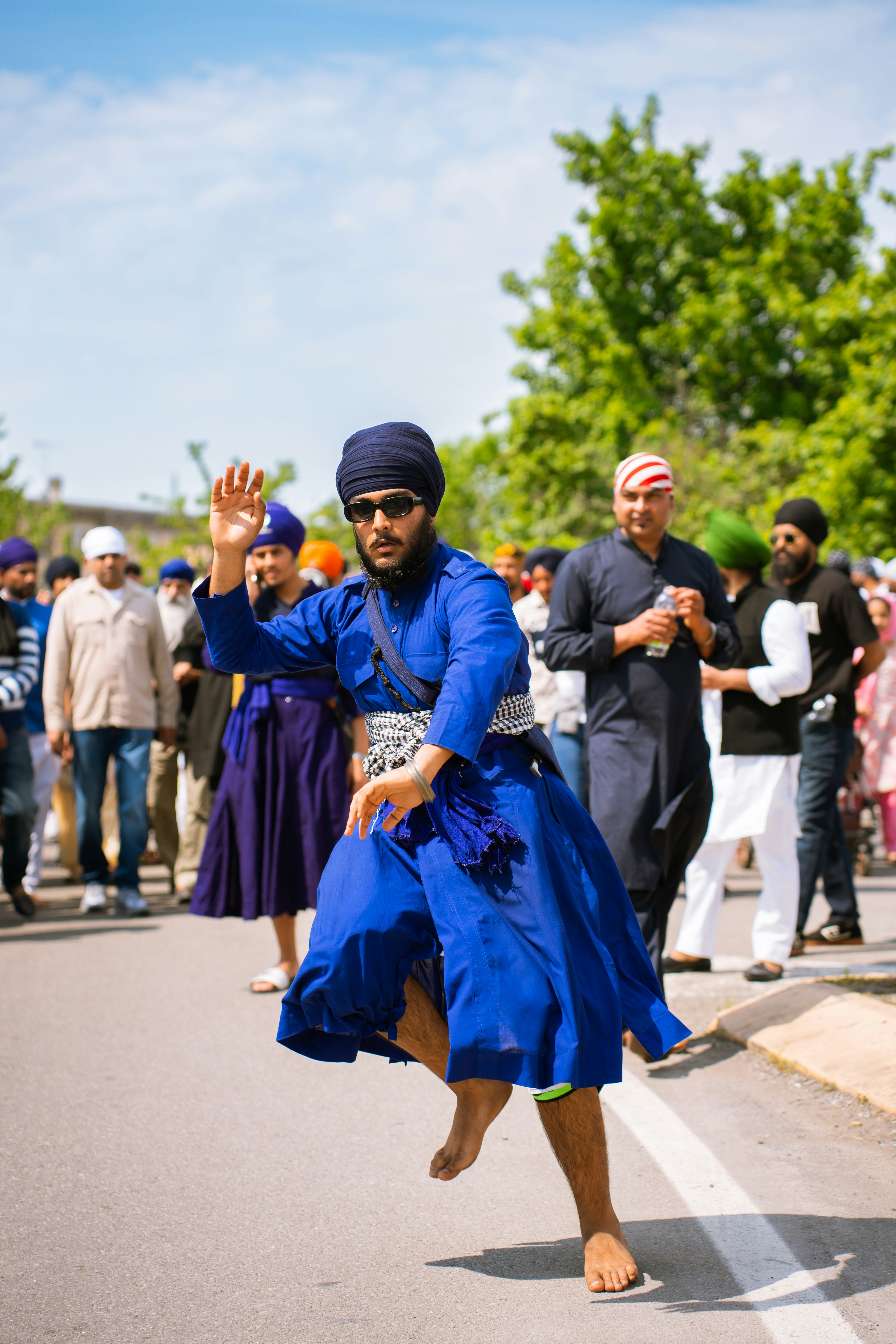 Blue-sashed Dancer in Motion Amid a Ring of Observers