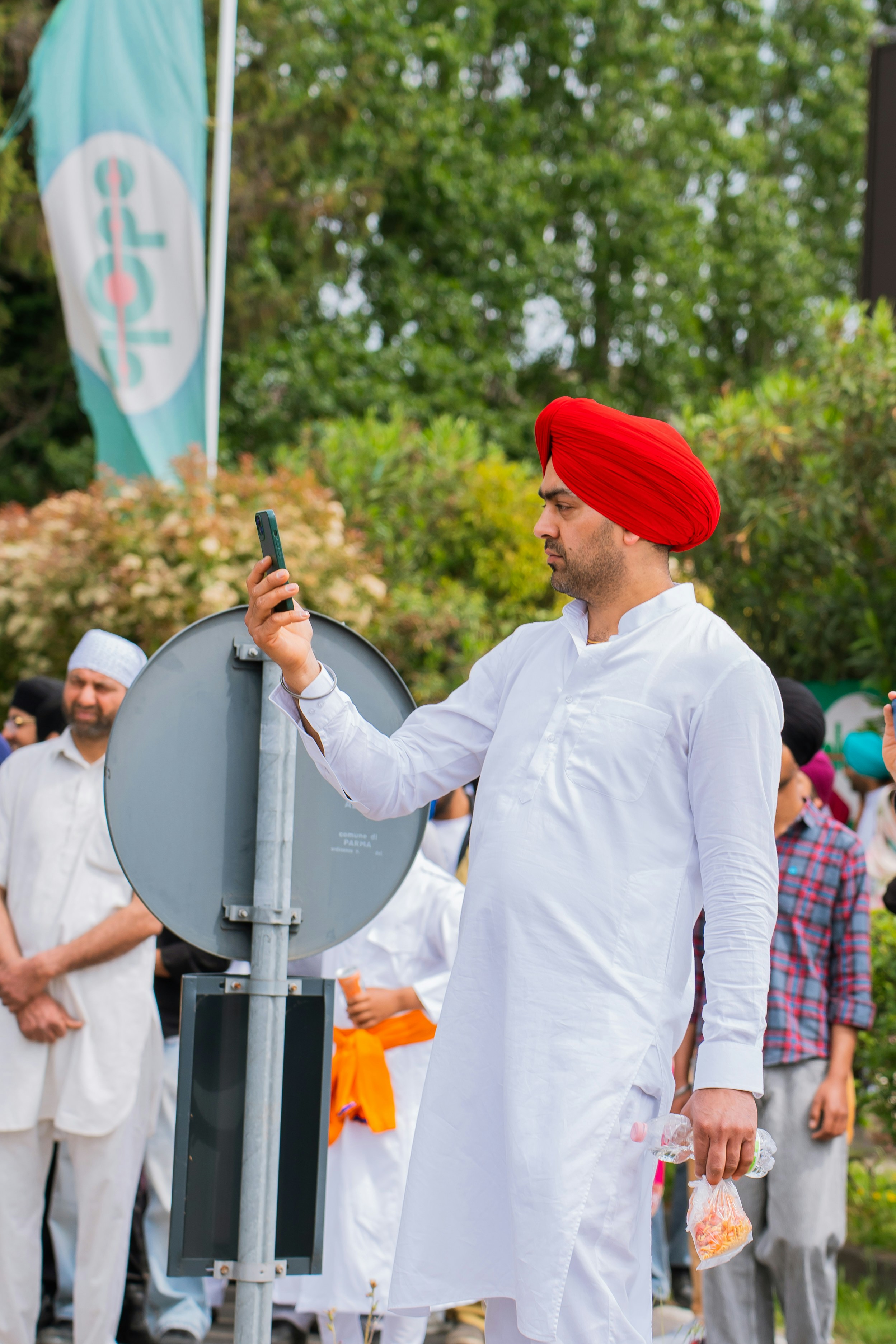 Red Turban, White Kurta: A Moment of Selfie Amid a Sikh Gathering