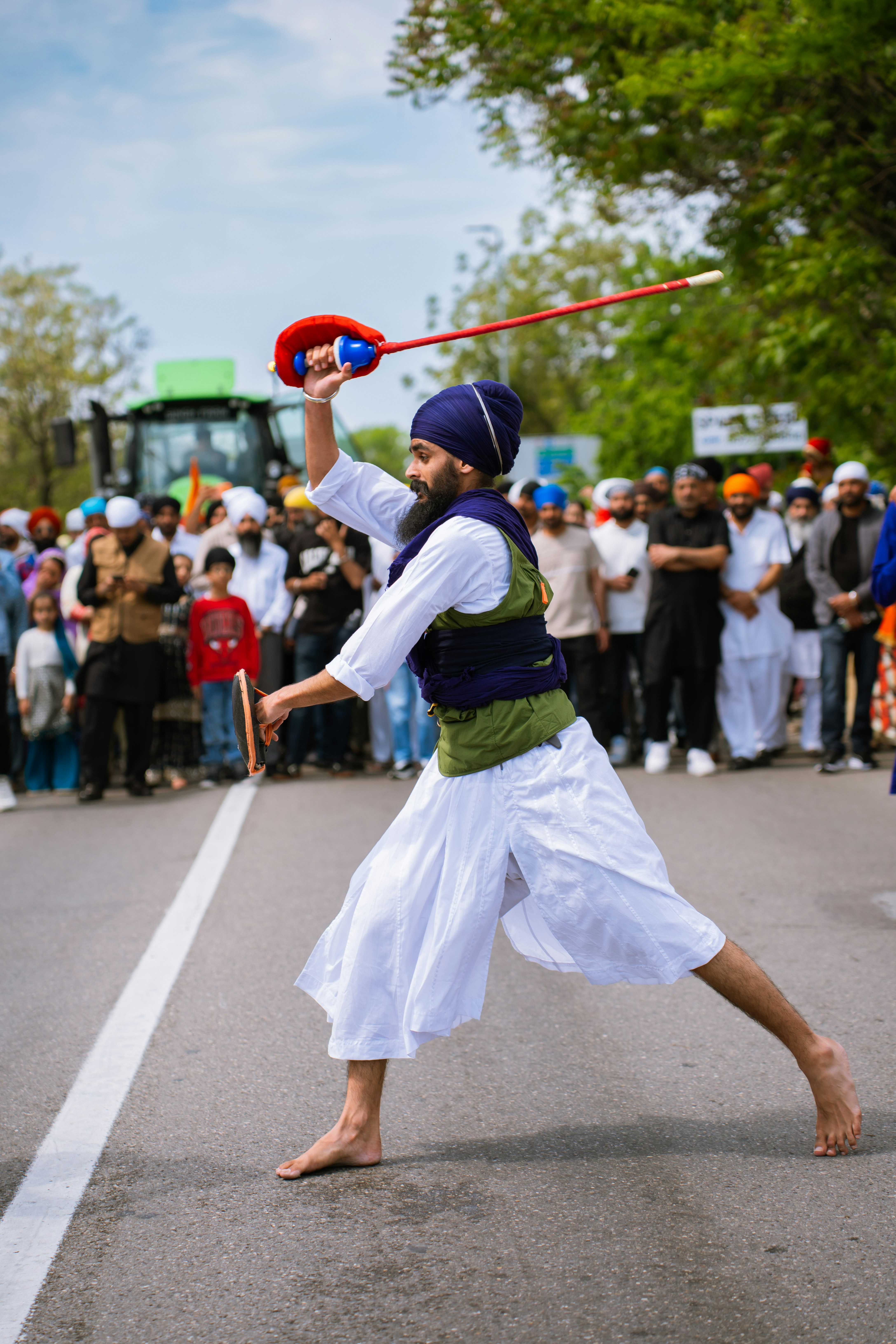 Breaking Dawn: A Saulet Warrior Unleashes a Long-Handled Muster on a City Street