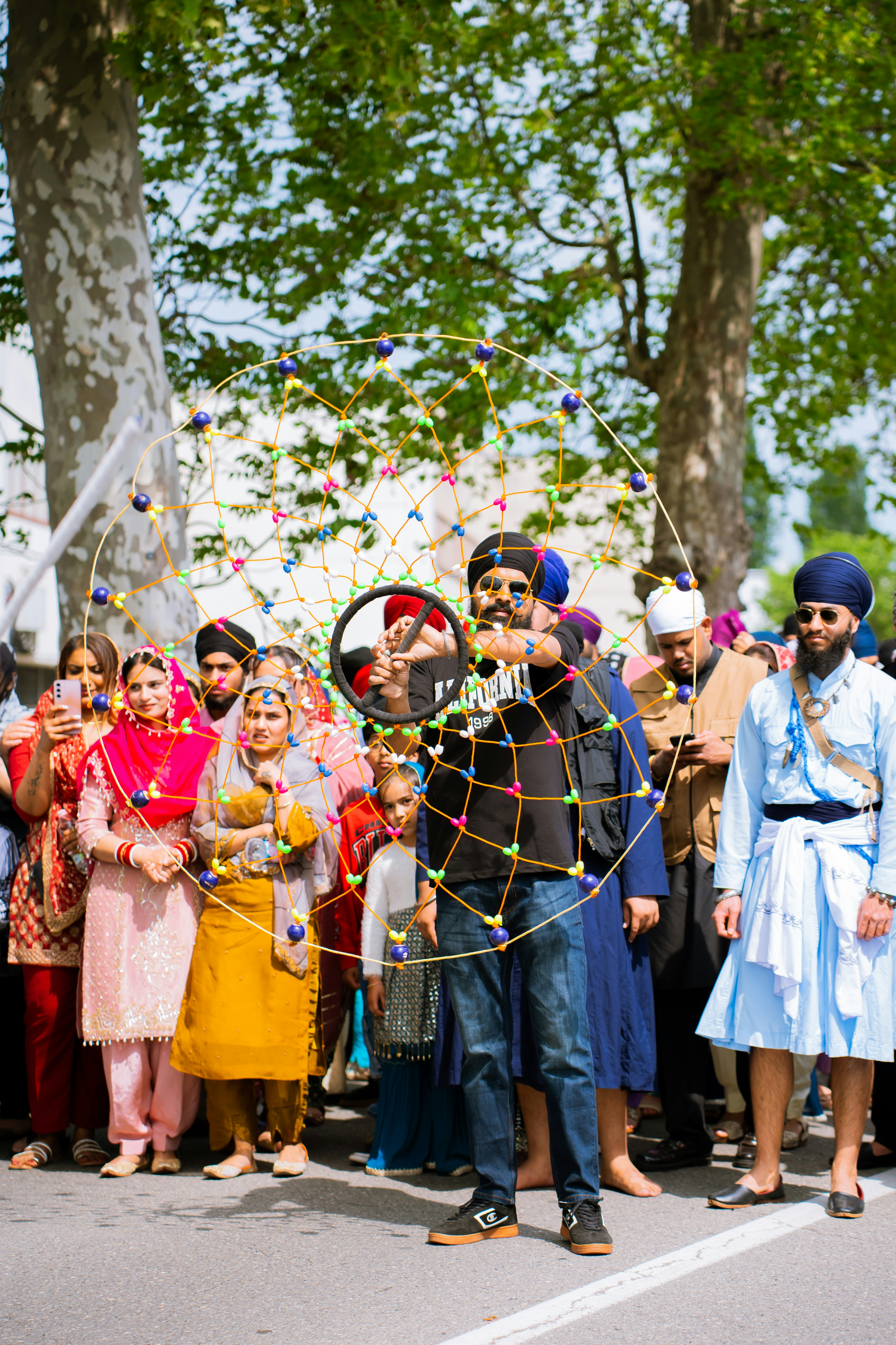 Circle of Color: A Multicultural Parade Framed by a Giant Dreamcatcher