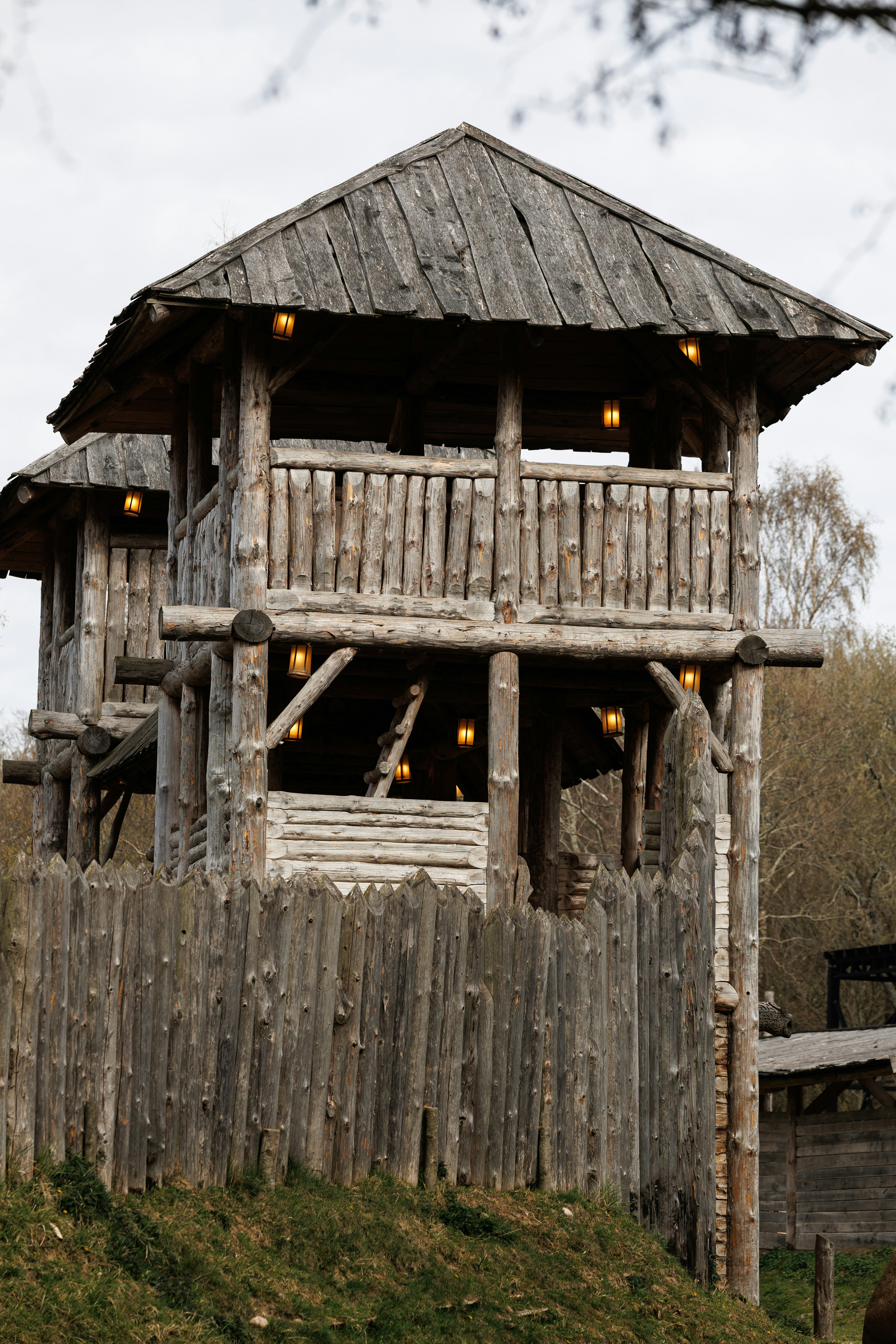 Weathered Watchtower: Timbered Fortitude Rising Above a Fenced Clearing