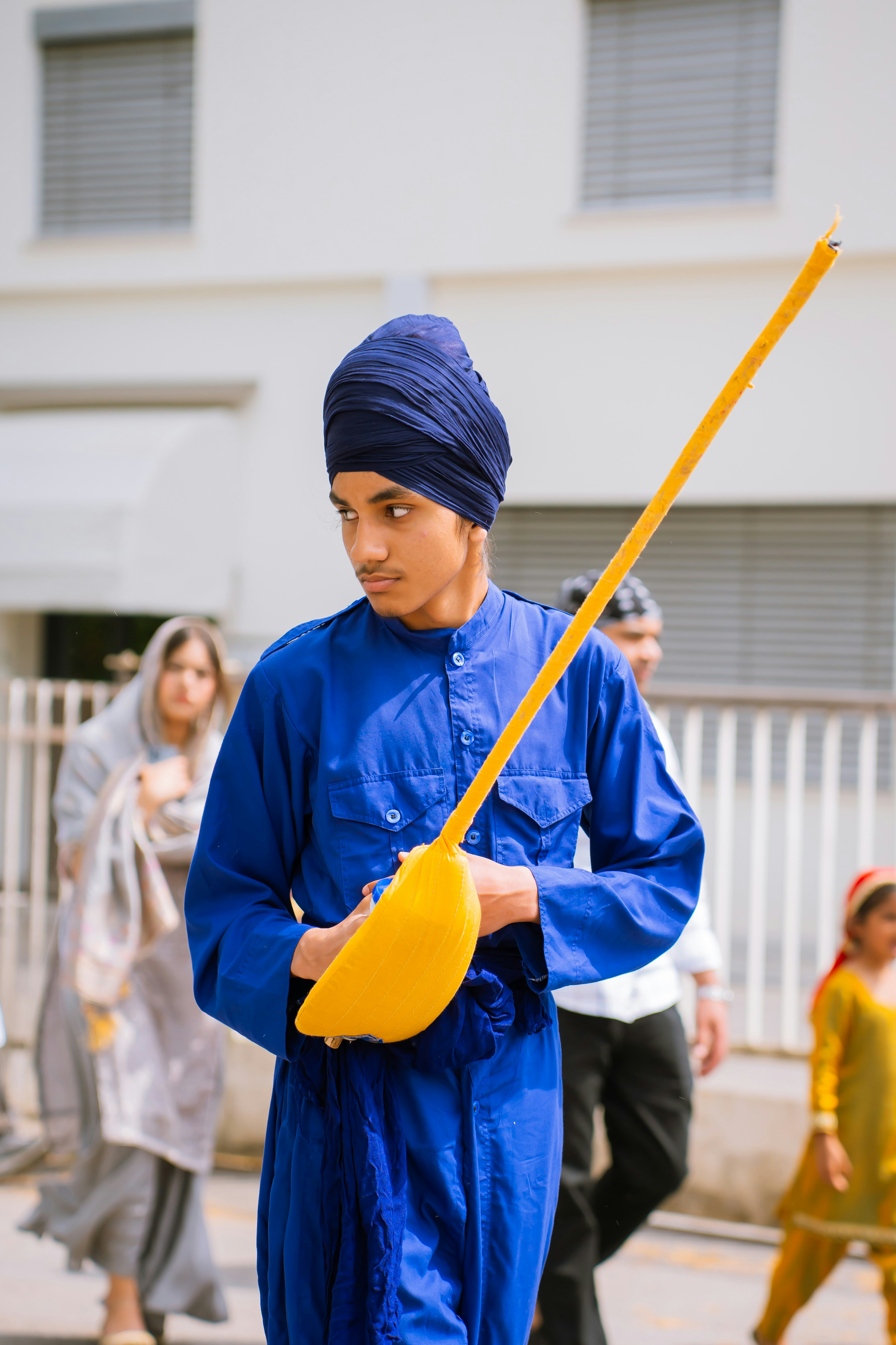 Blue Robe, Bright Lance: A Street Moment in Color