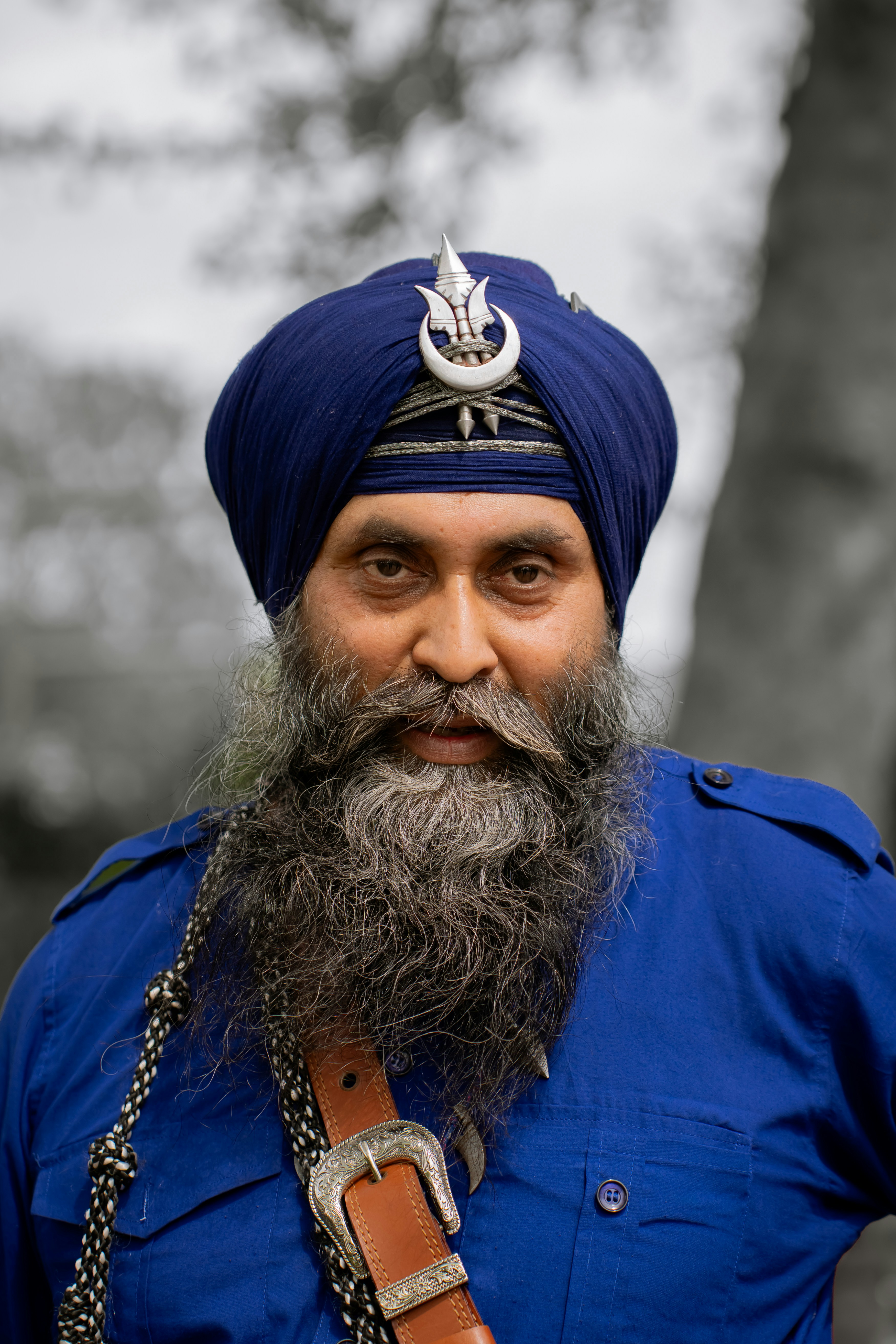  regal turbanned guardian: a close-up of a Sikh man in royal blue attire