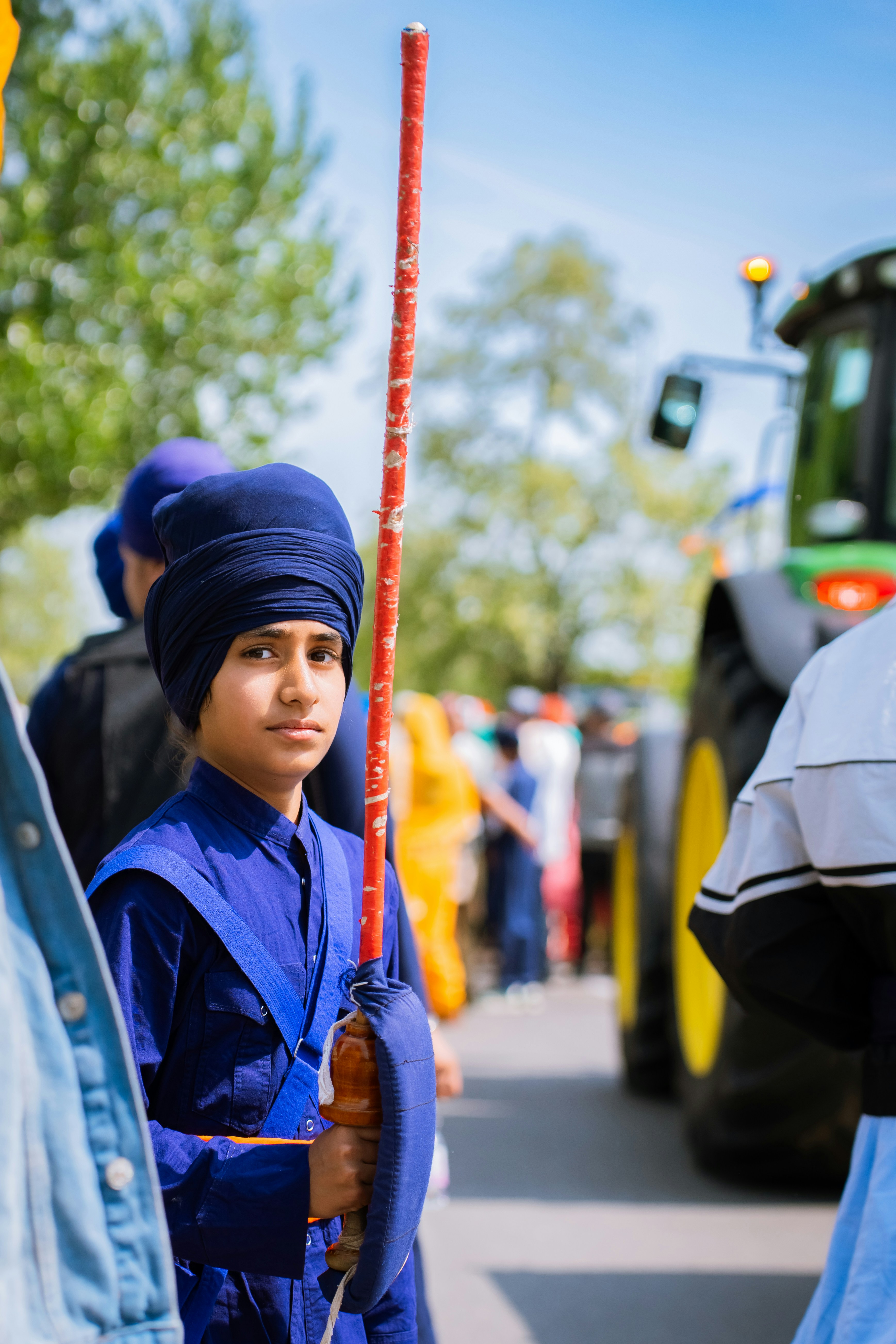 Blue-clad Sentinel with a Red Staff at a Farm Vehicle Event
