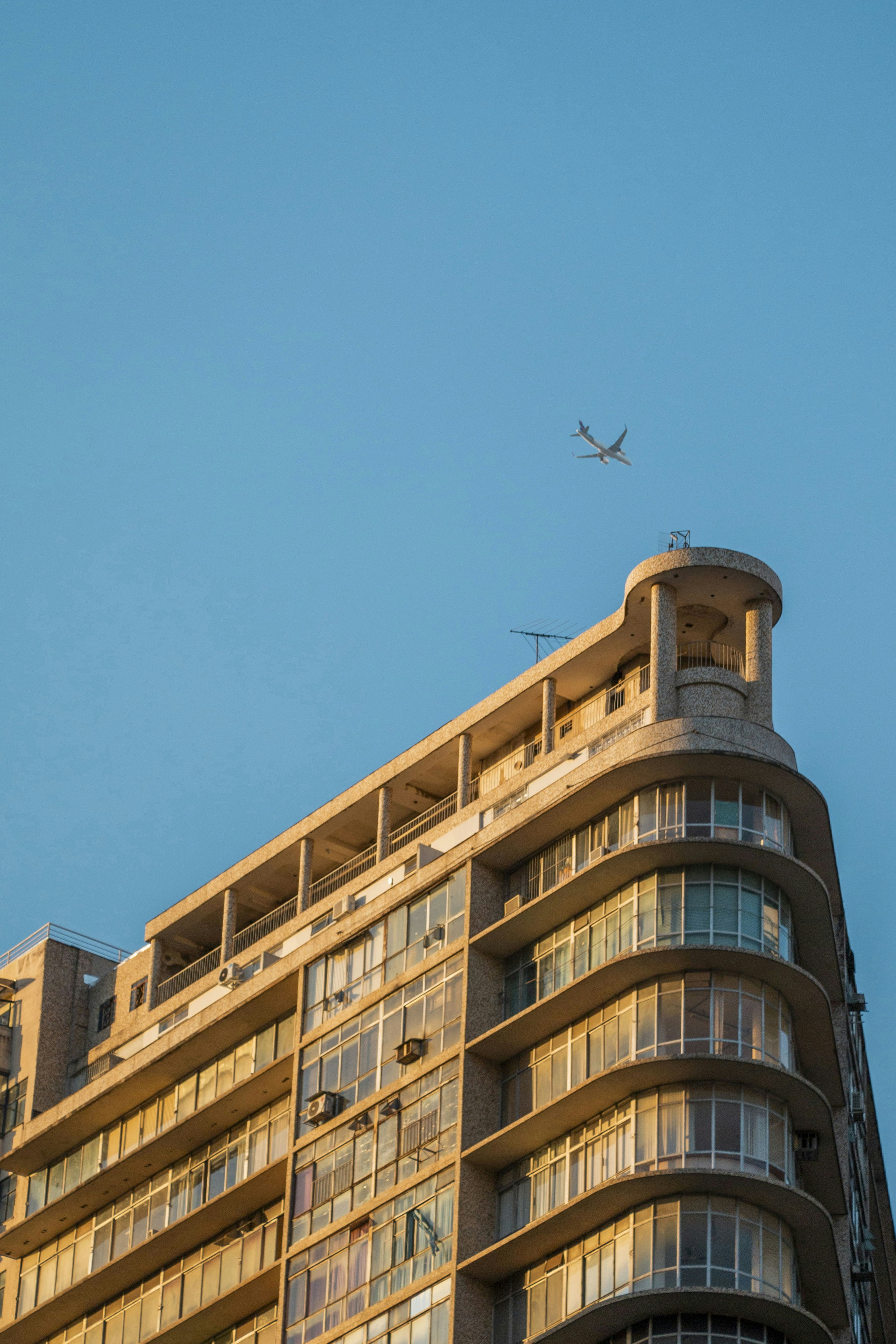 Airborne silhouette above a sunlit corner tower