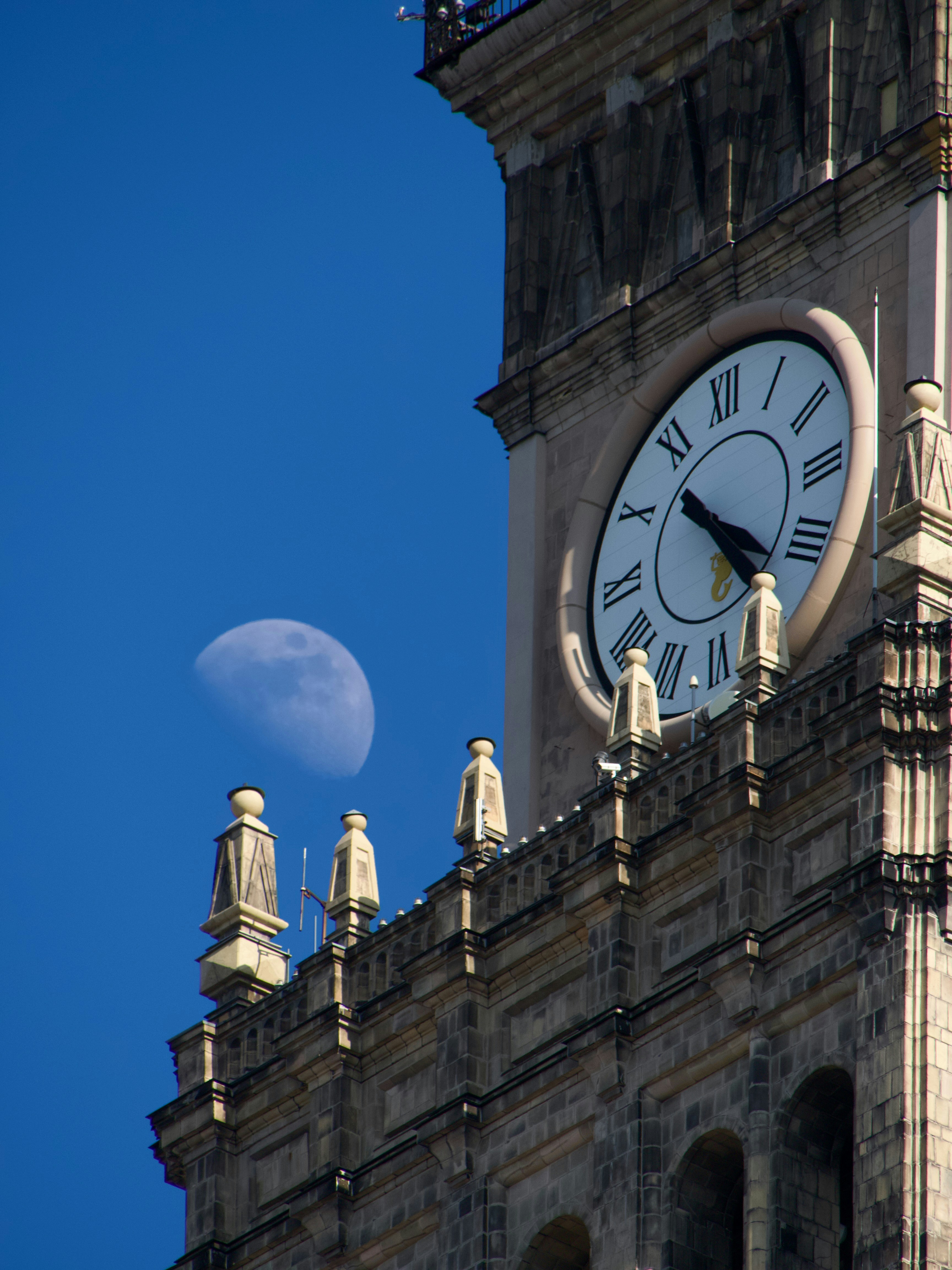 Moonlit Clocktower: A Quiet Touch Beside the Night Marble