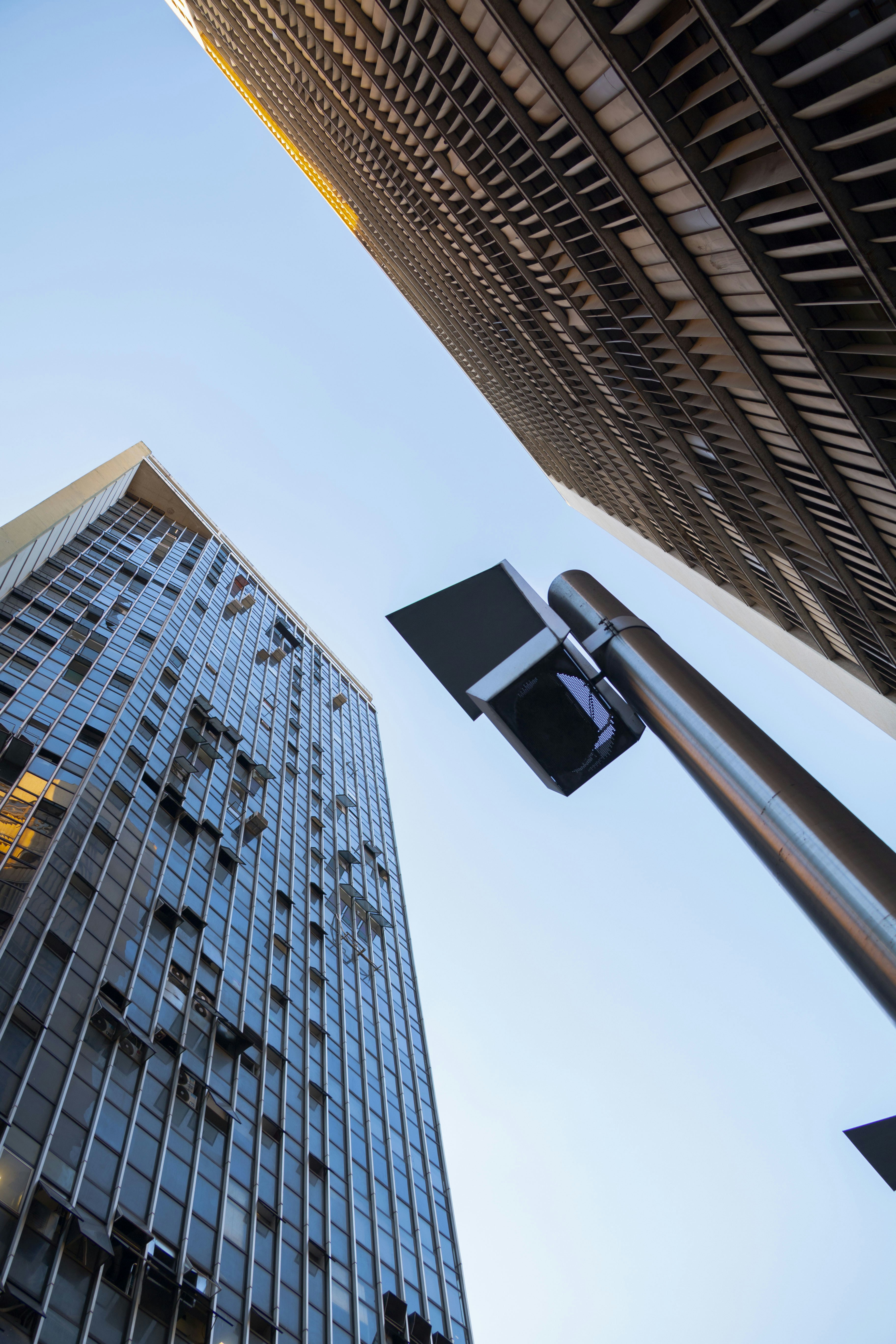 Skyward Convergence: A Street-Level View of Tall Glass and Steel