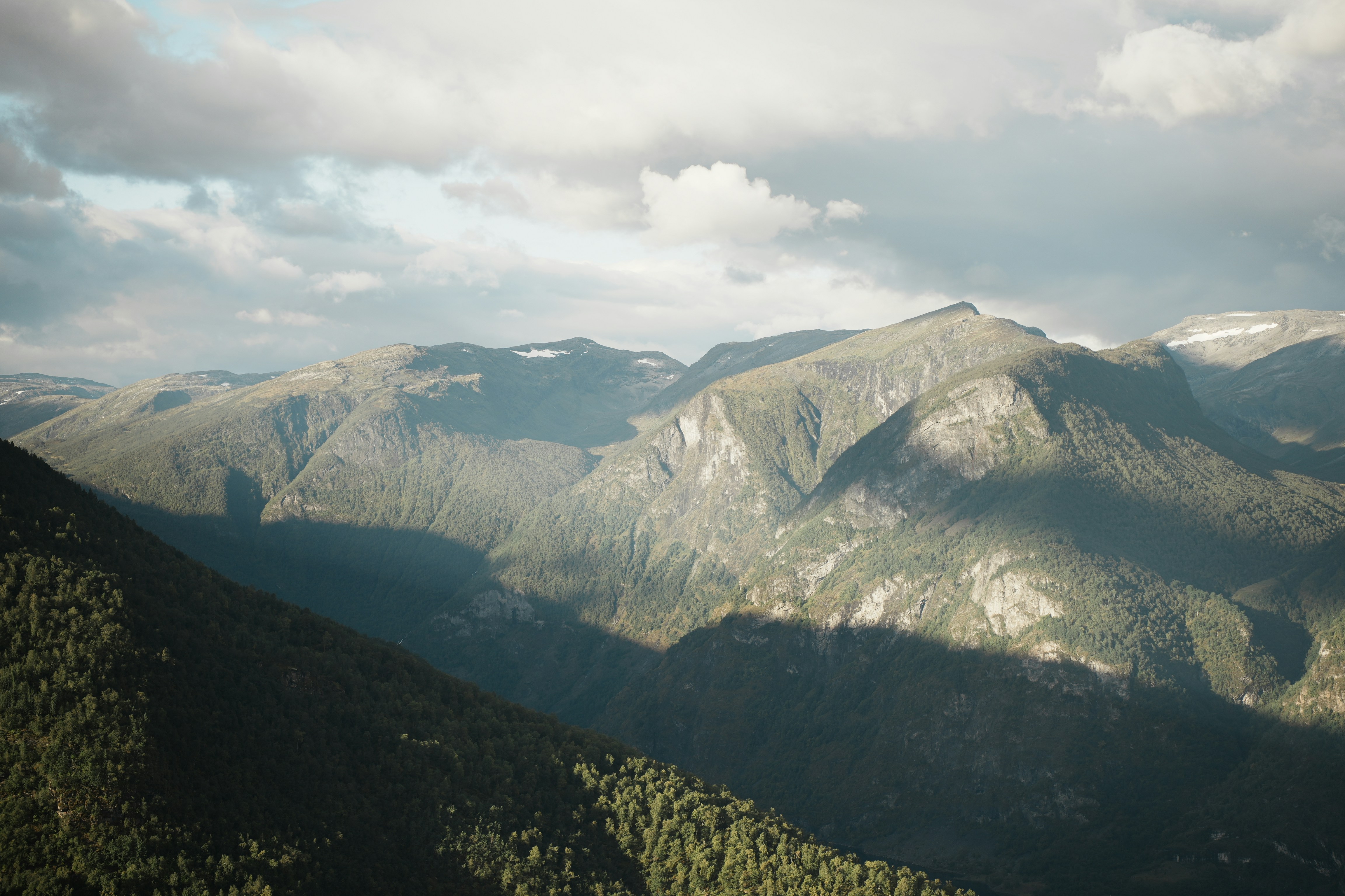 Emerald Valleys Beneath a Dappled Sky