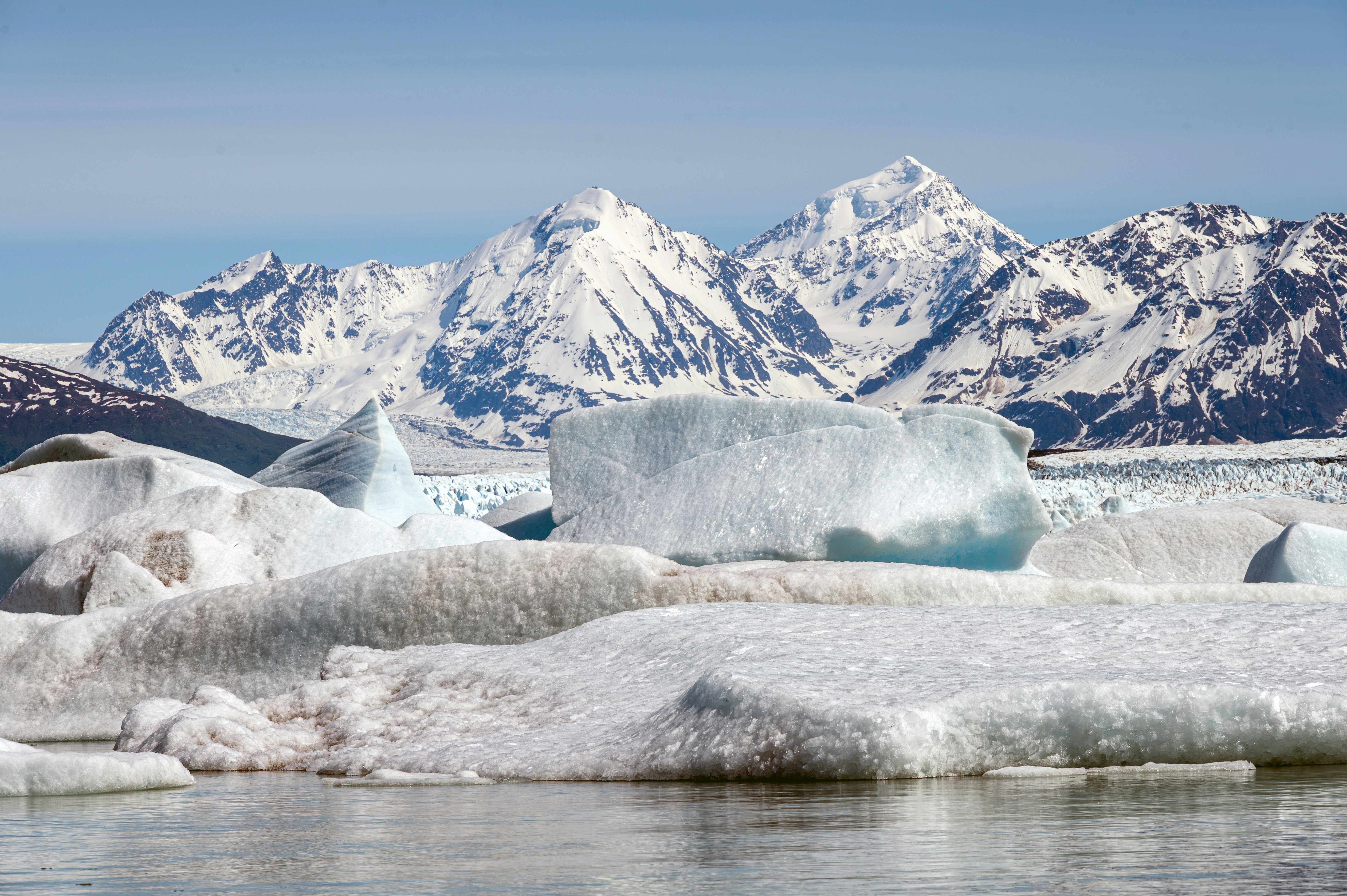 Ice Floes and Glacier Peaks Under a Clear Sky
