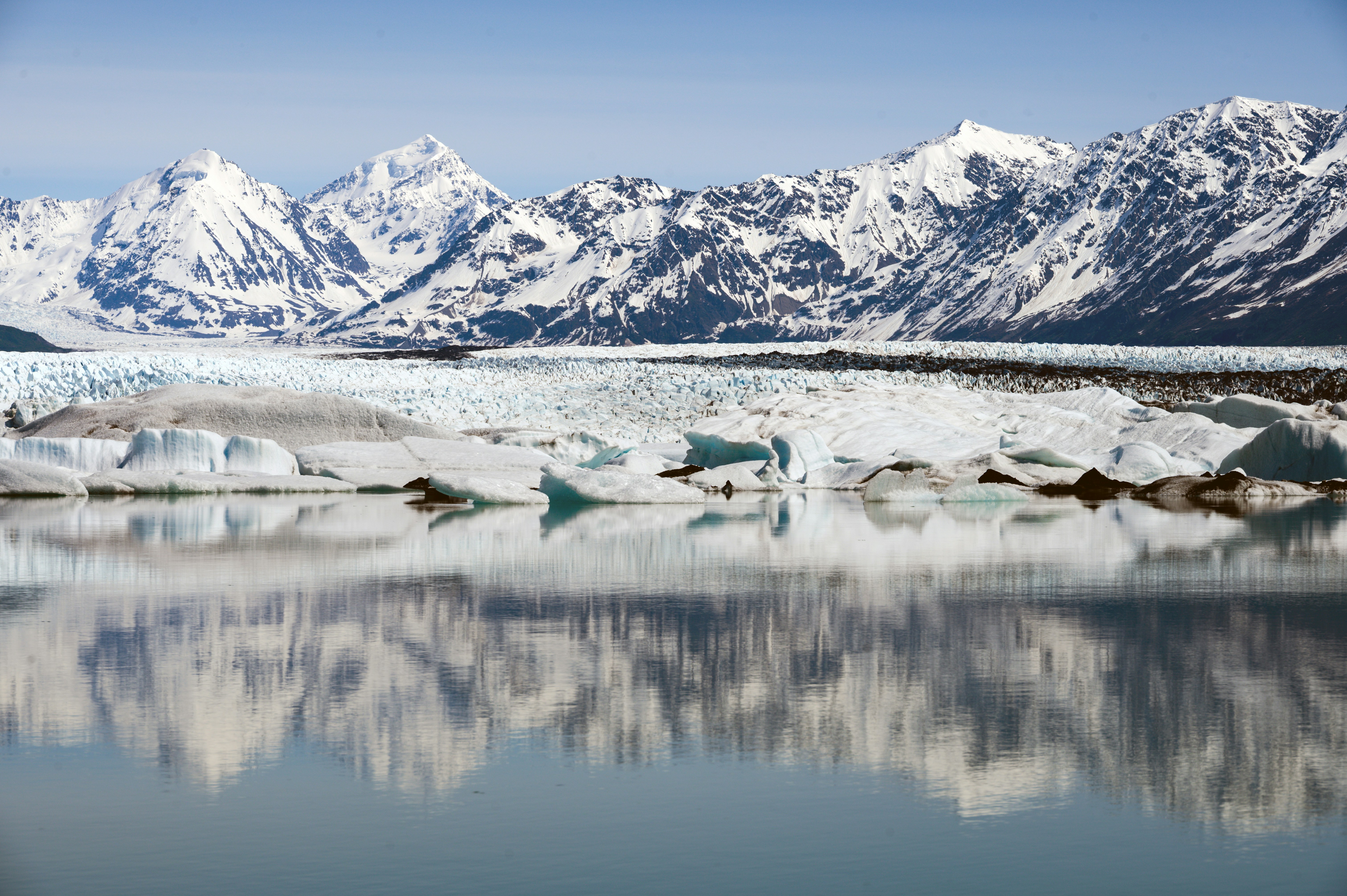 Glacial Peaks Mirror into a Frozen Fjord