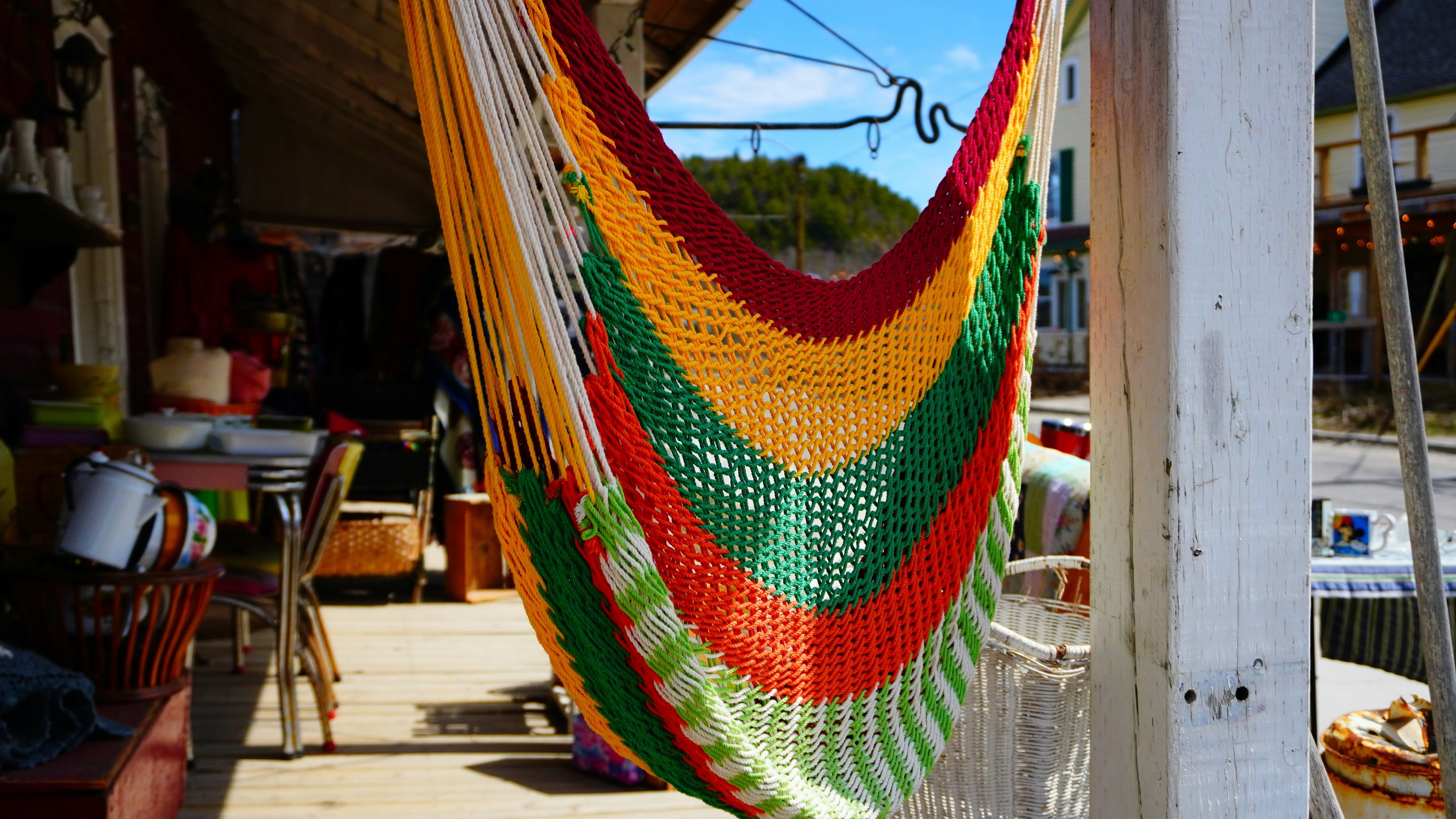 Sunlit Hammock of Color: A Coastal Market Slip Covered in Yarn Stripes