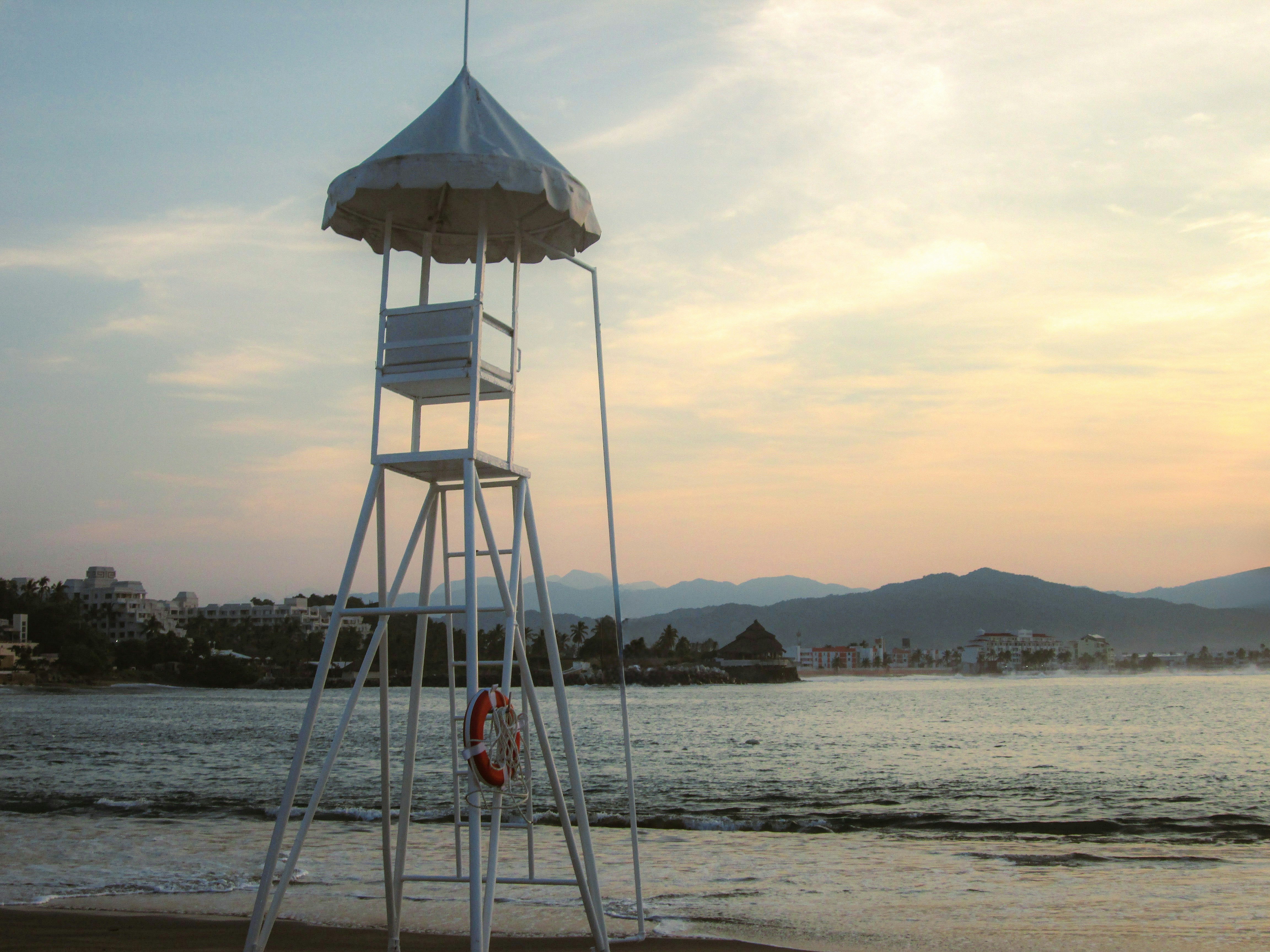 Lifeguard Tower at Sunset Over Calm Coastal Waters