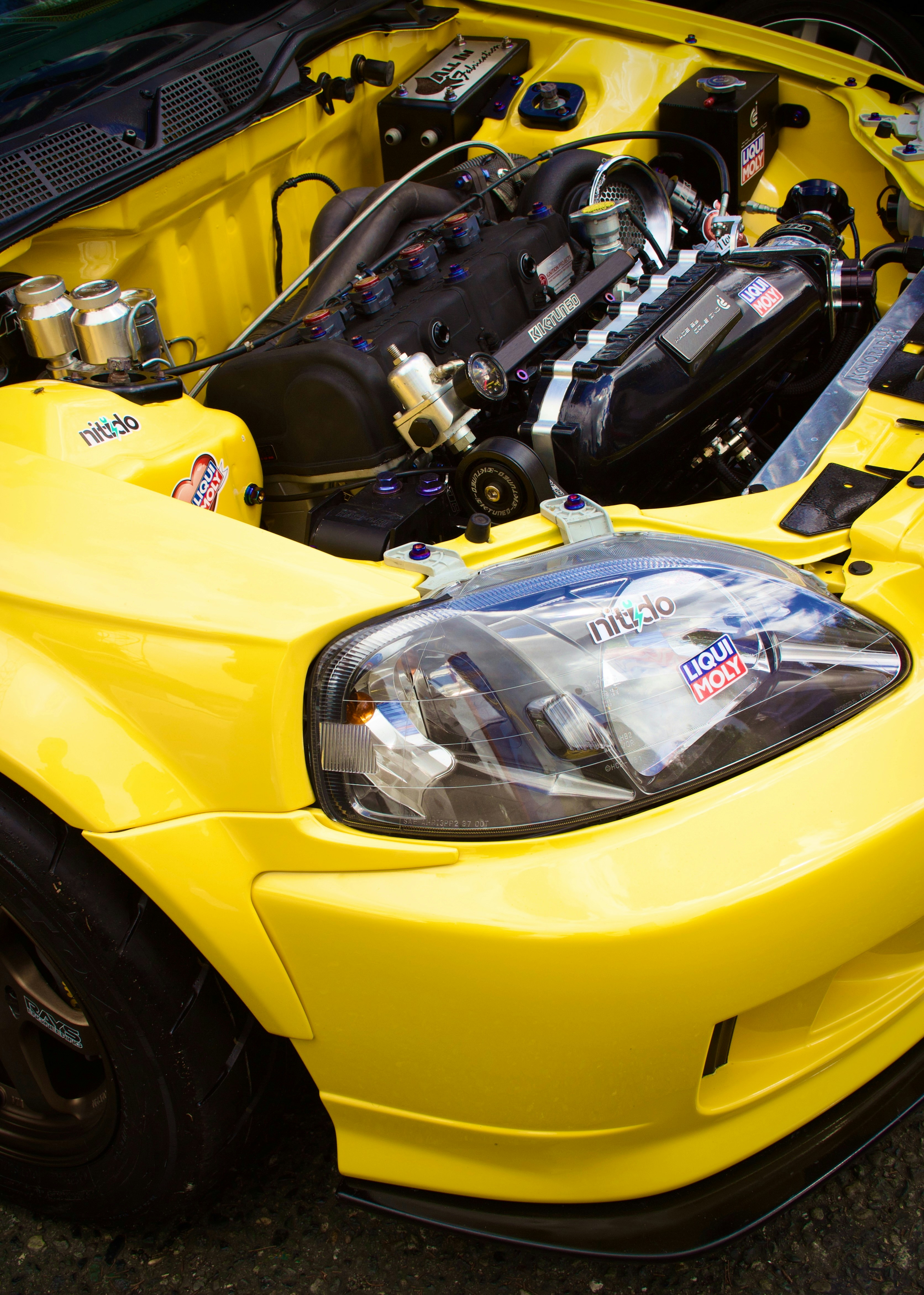 Turbocharged Yellow Dream: Exposed Engine Under Hood