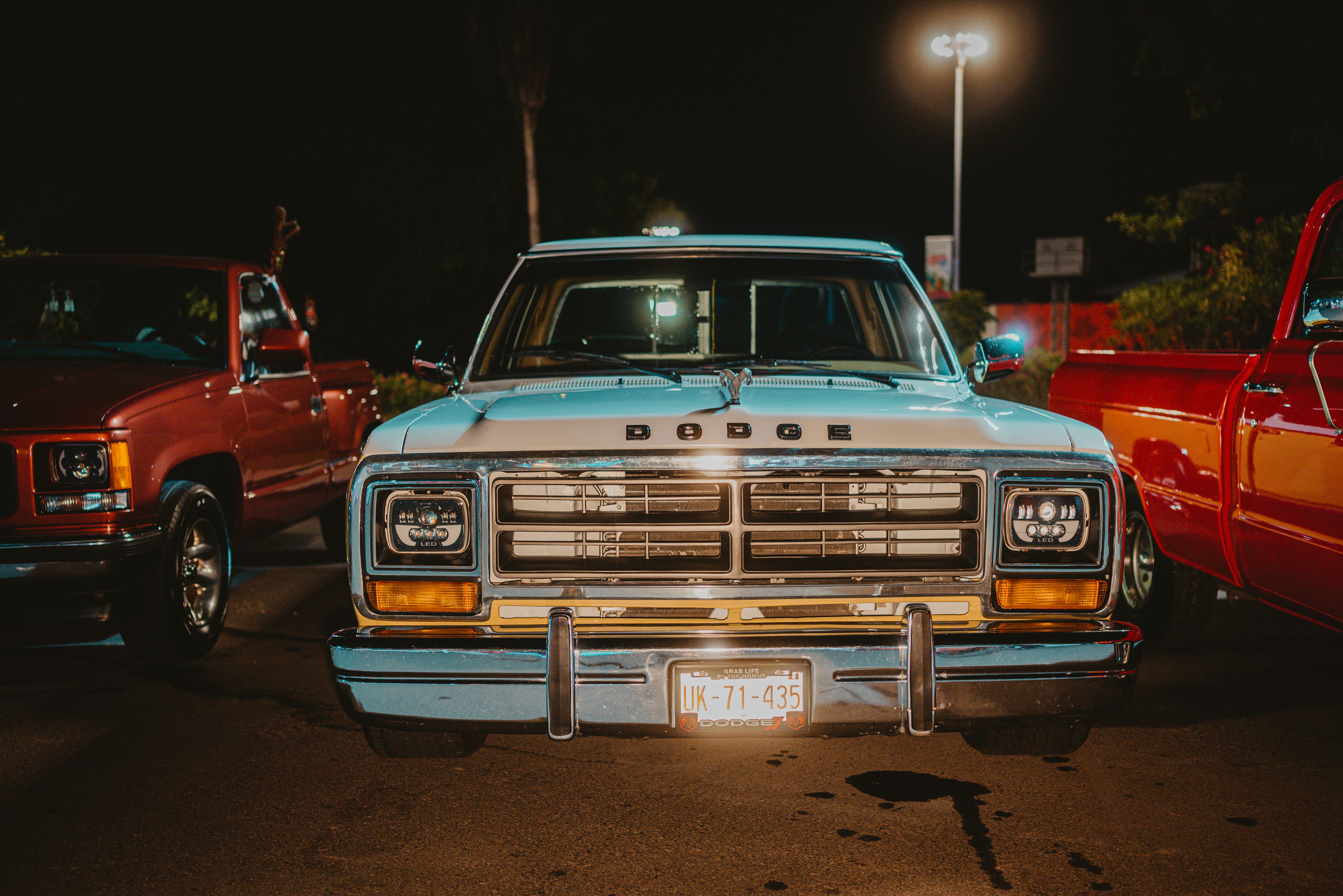 Vintage dodge pickup truck parked at night.