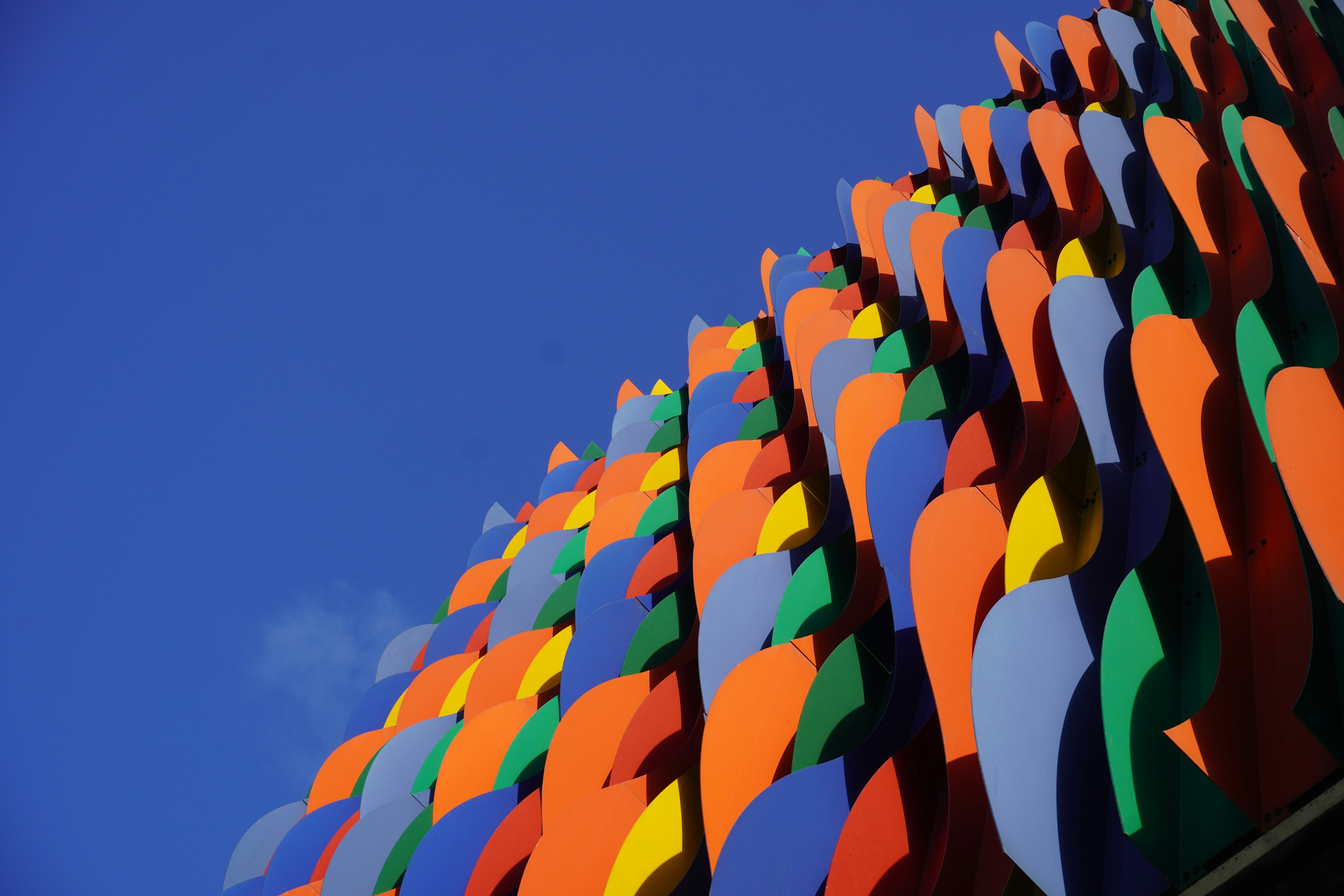 Rainbow-Tiled Facade Reaching Toward the Sky