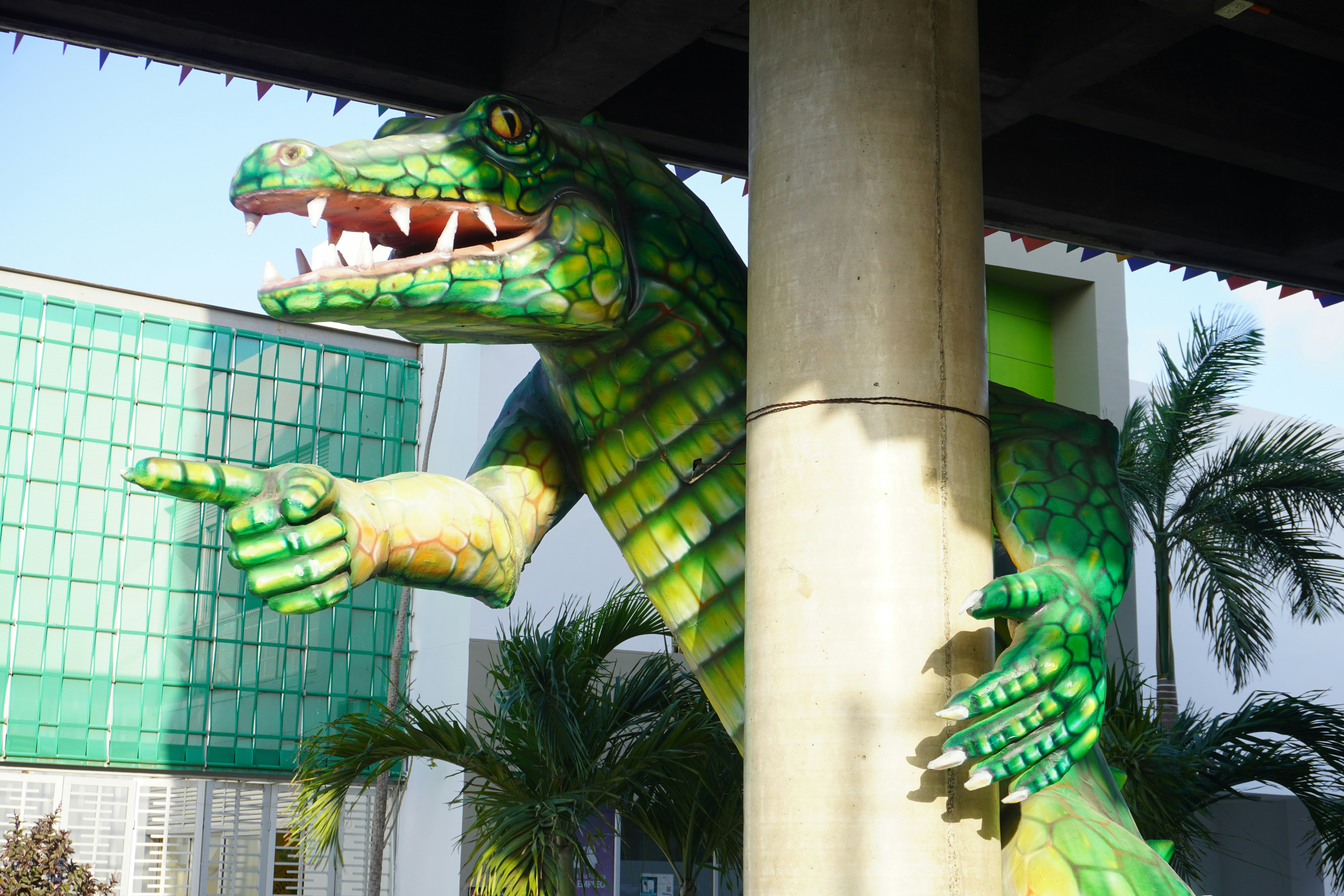 Green Goliath: A Playful Monster Reaches from the Pillar