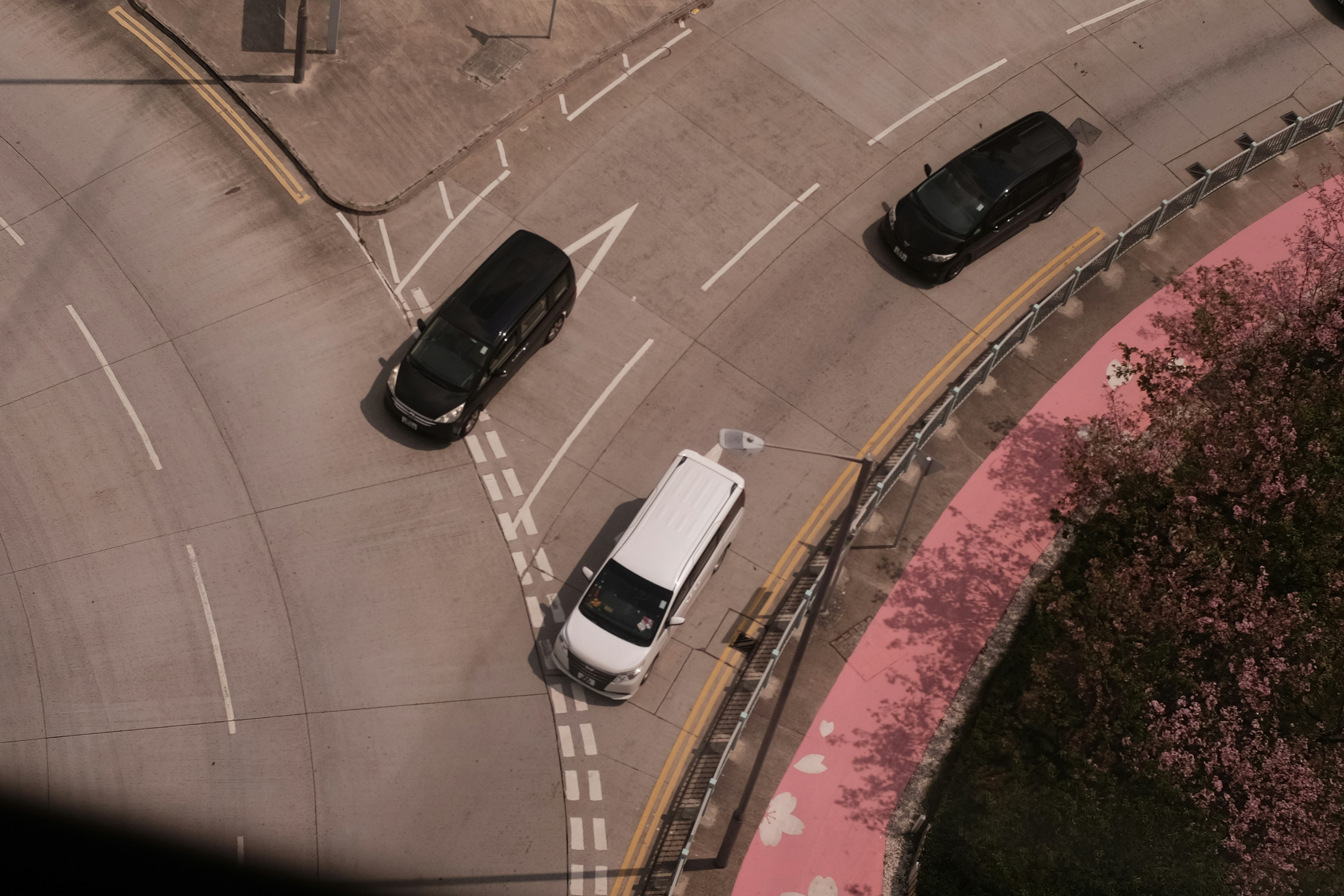 Aerial Traffic Sketch: Cars Circling a Pink-Threaded Curve