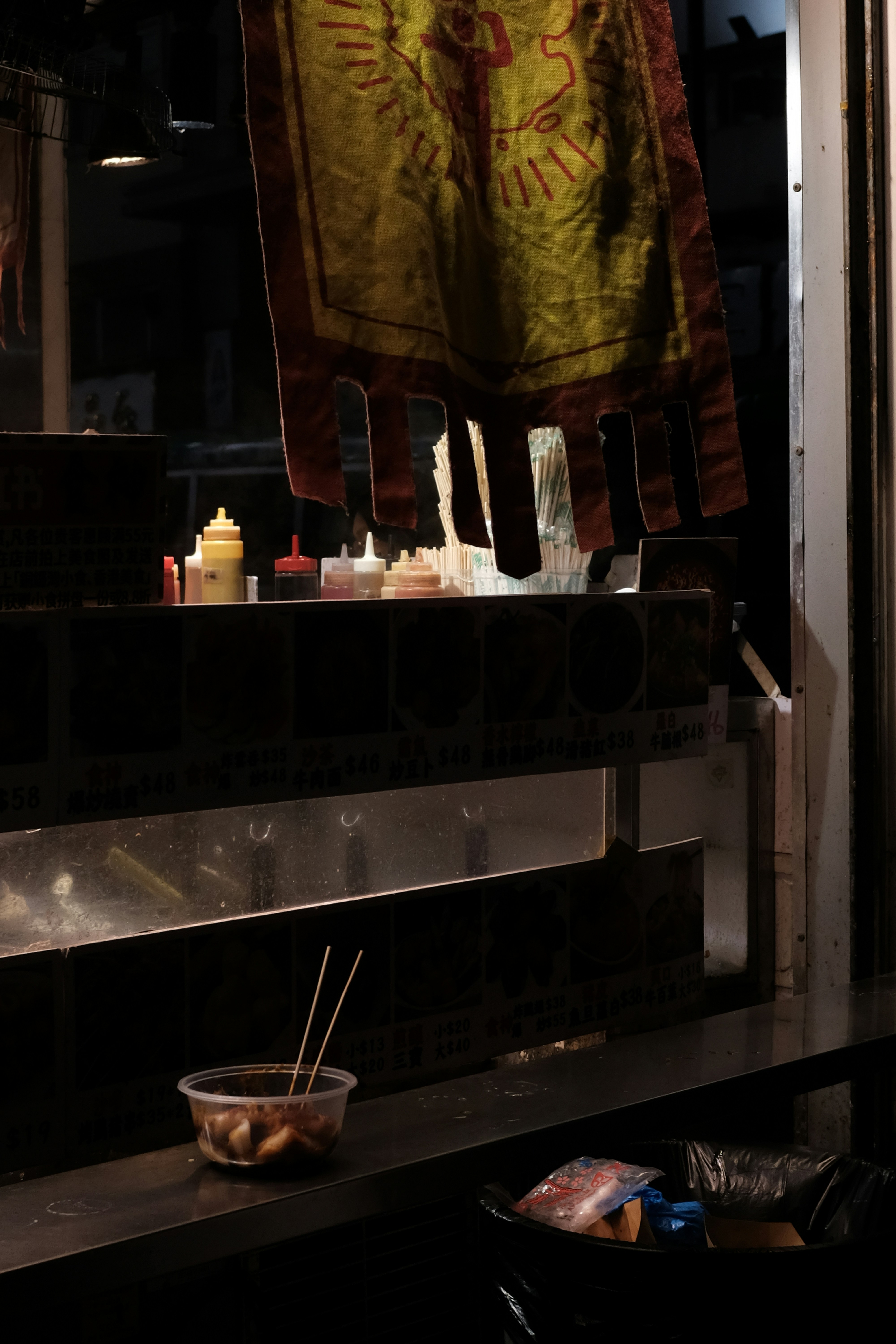 After-Hours Snack Stop Under a Tattered Banner