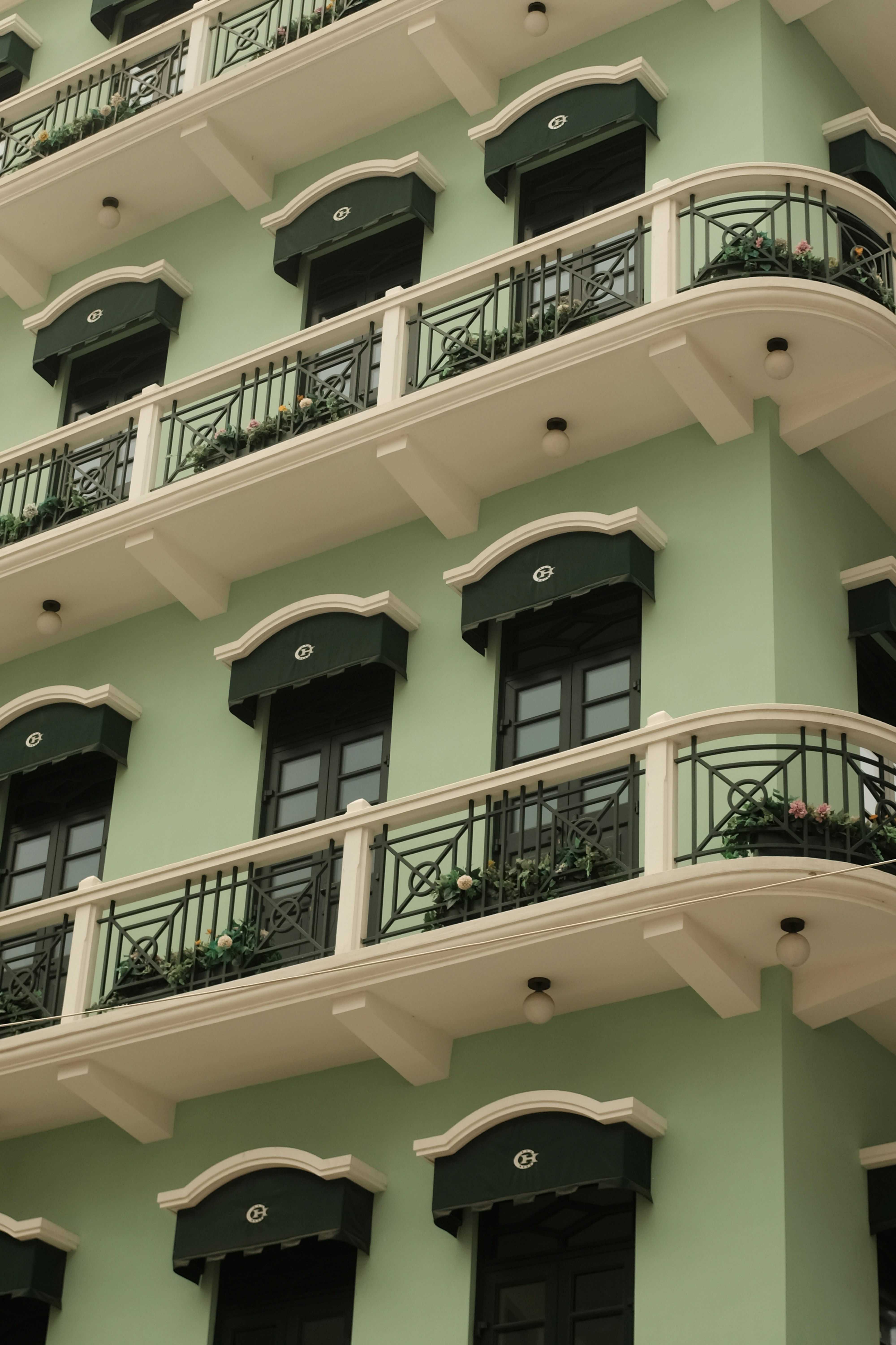 Green Crescent: Repeating Balconies and Arched Shutters