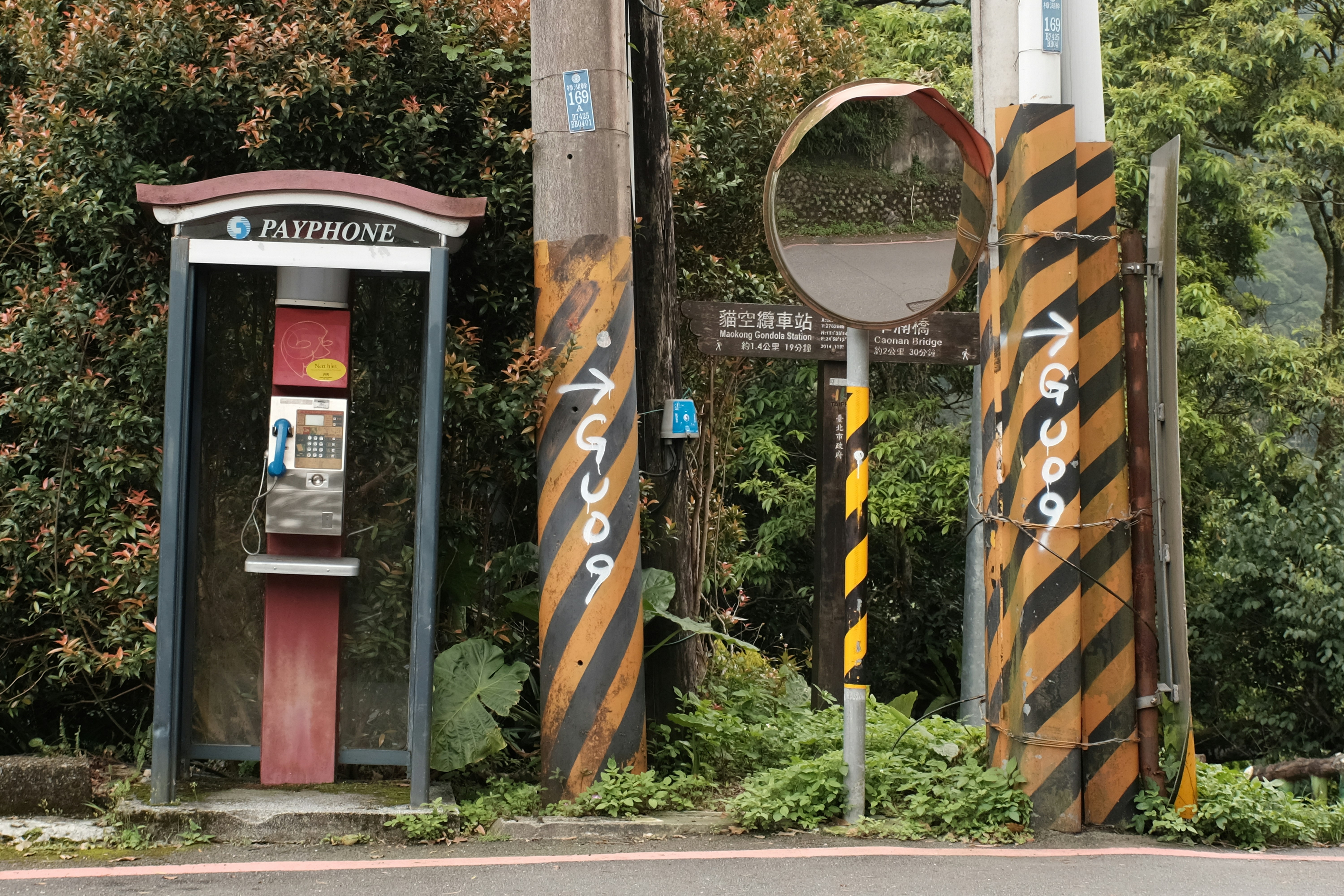 Urban Red Phone Booths and Striped Poles in Quiet Street