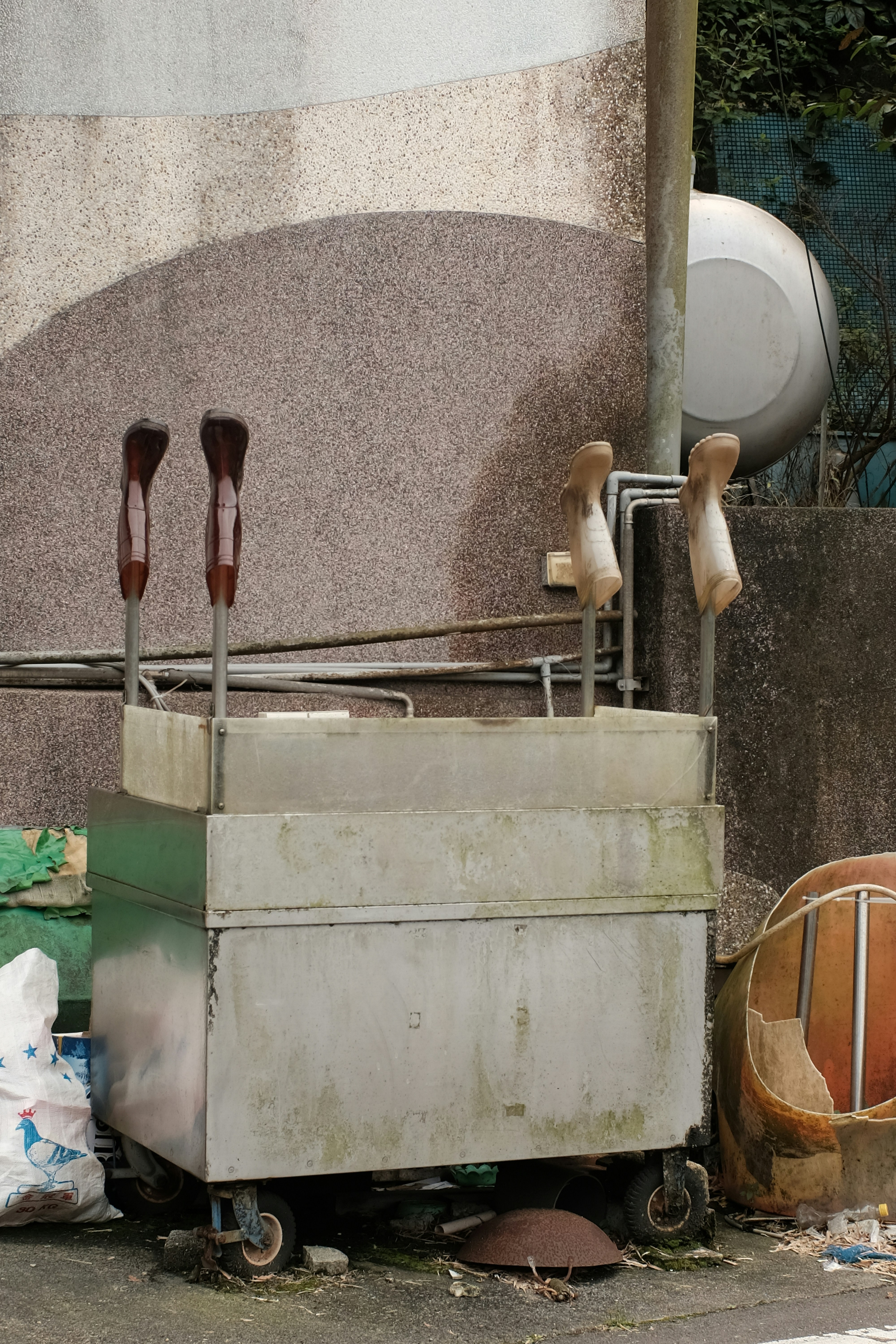 Industrial Quiet: Boots and Trolley in a Quiet Courtyard