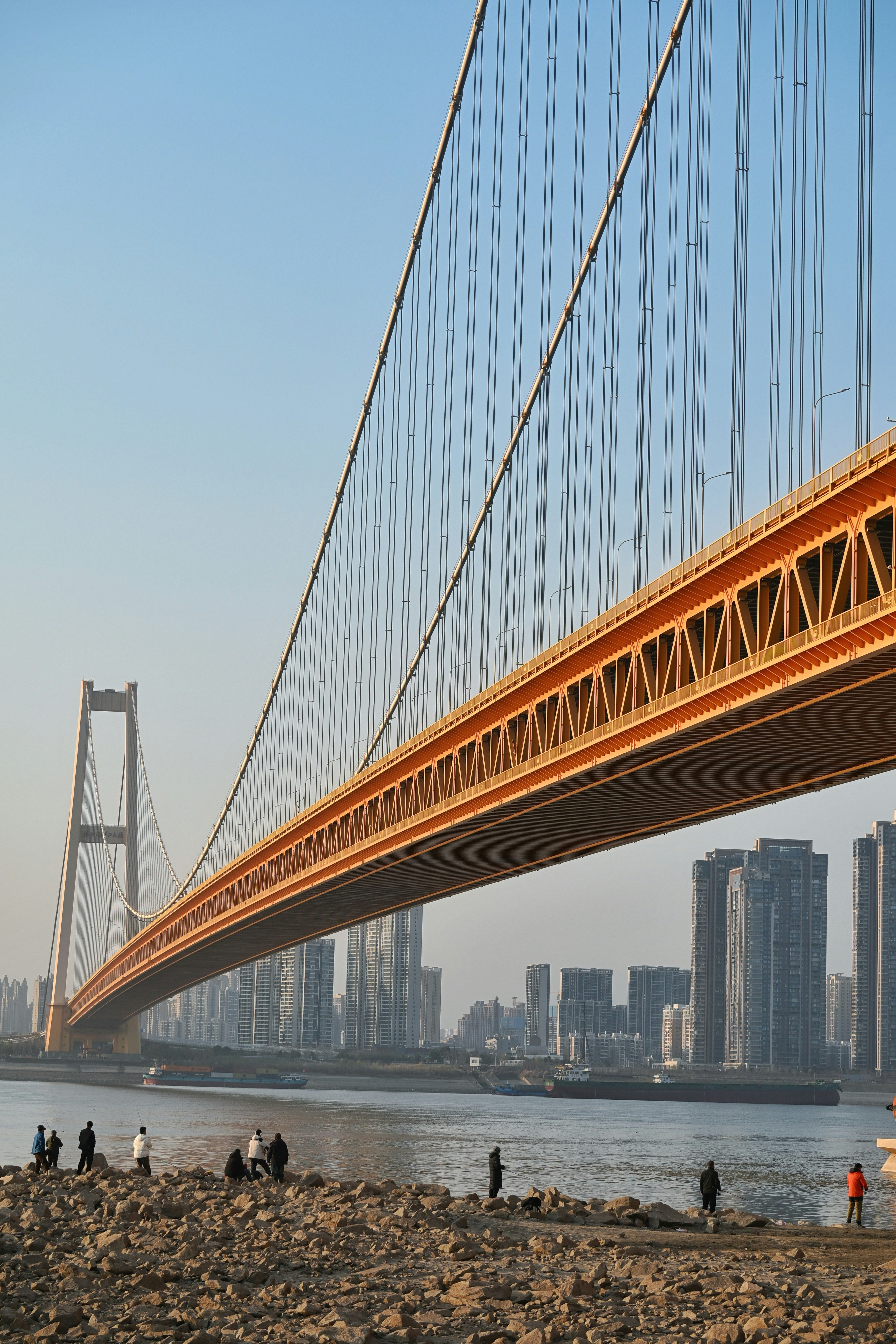 Bridge over the City: Aerial cables and orange arching iron