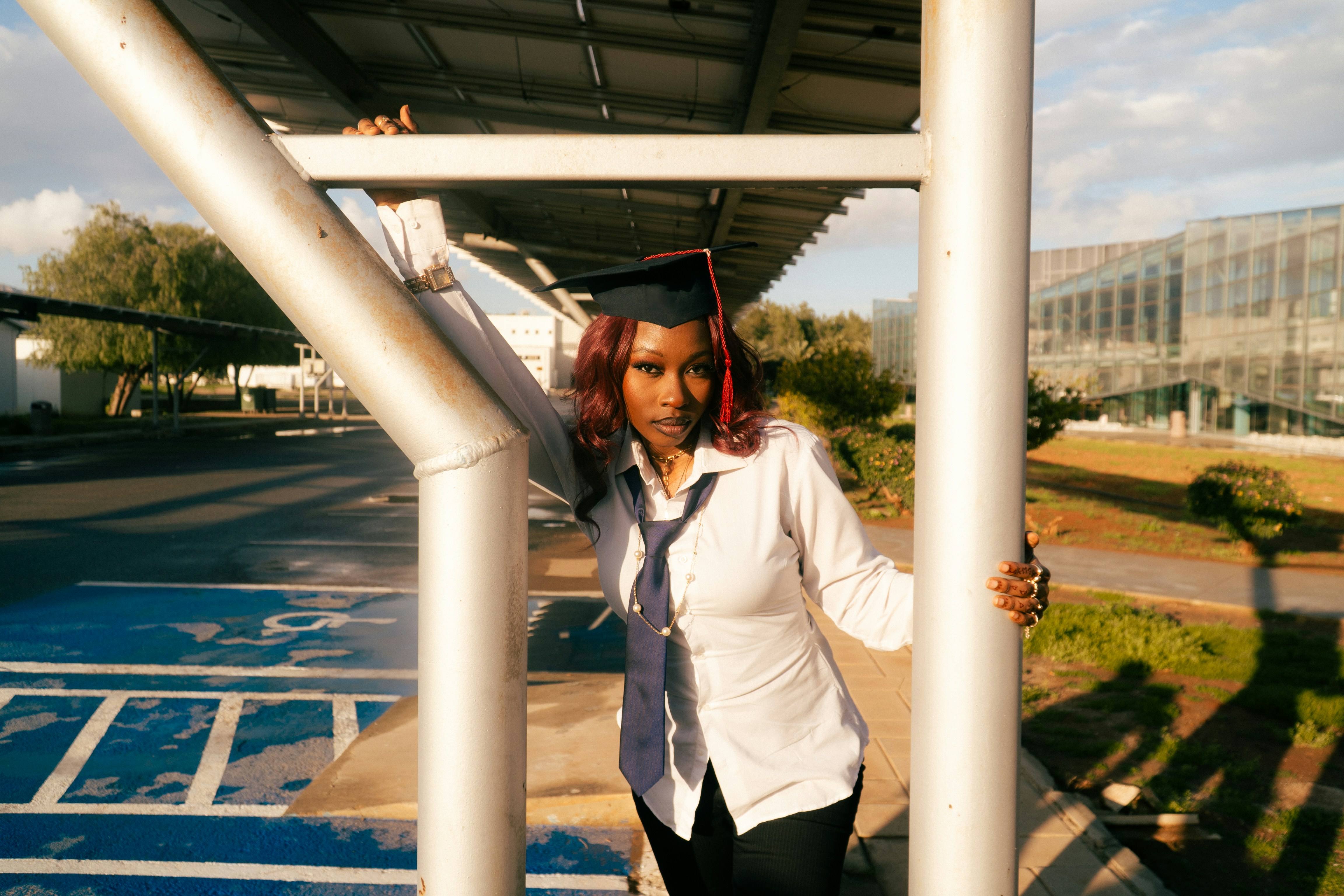 Graduation Grace Between Metal Columns at Sunset Campus