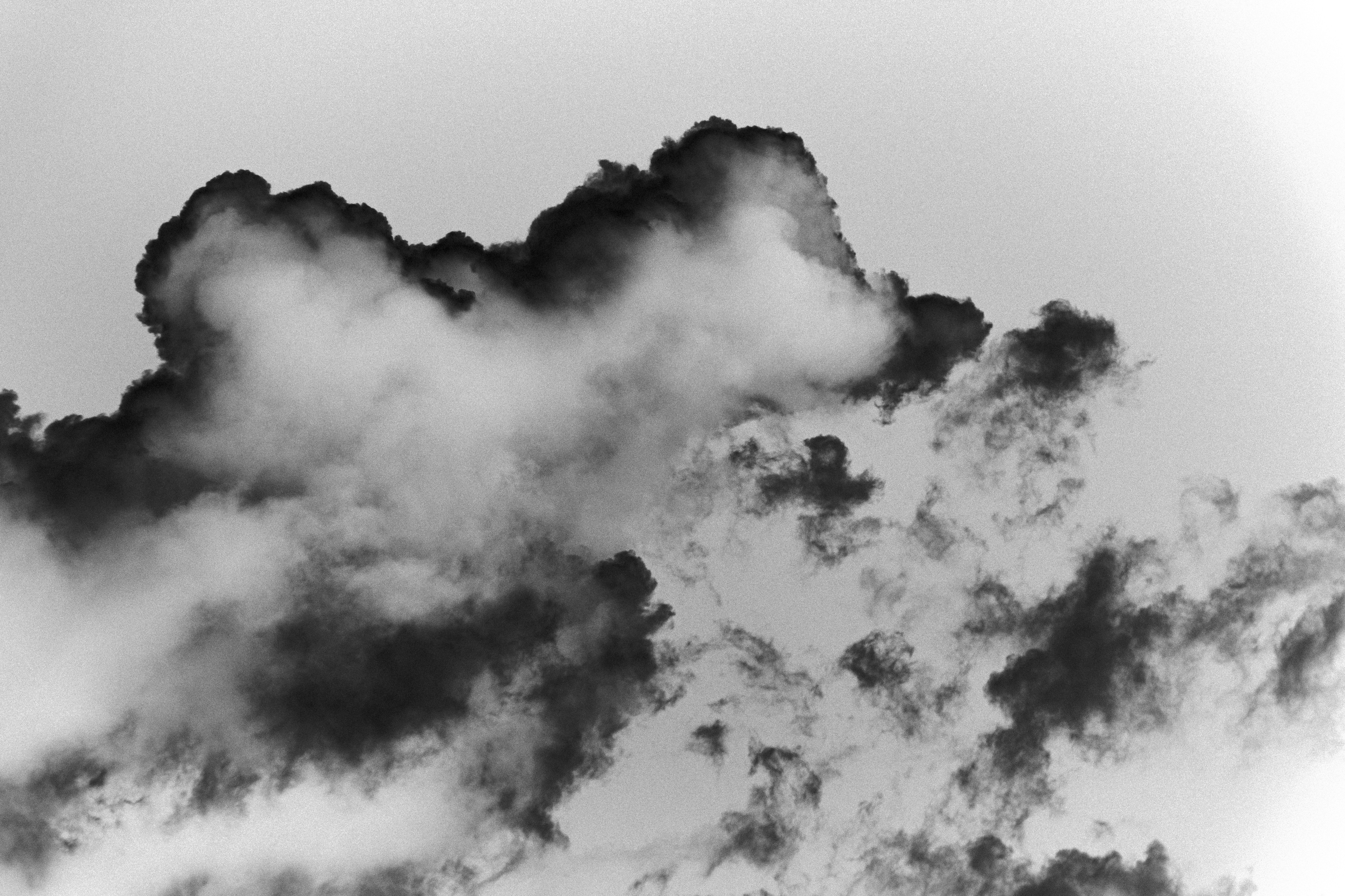 Monochrome cloudscape with high-contrast tonal separation and soft gradient sky, emphasizing cloud edges and texture.
