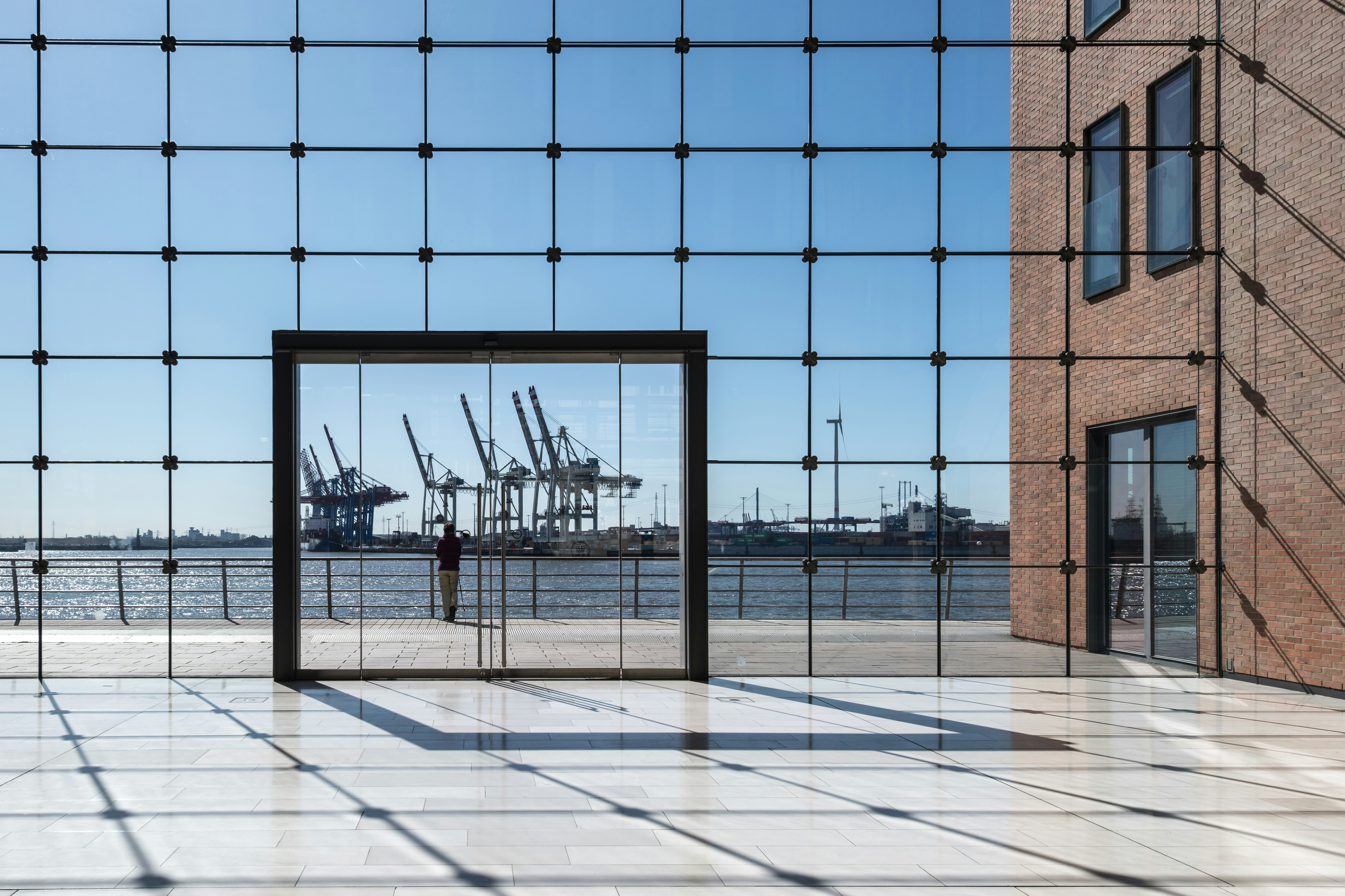Framed in Glass: A Harbor Scene Through a Grid of Reflections