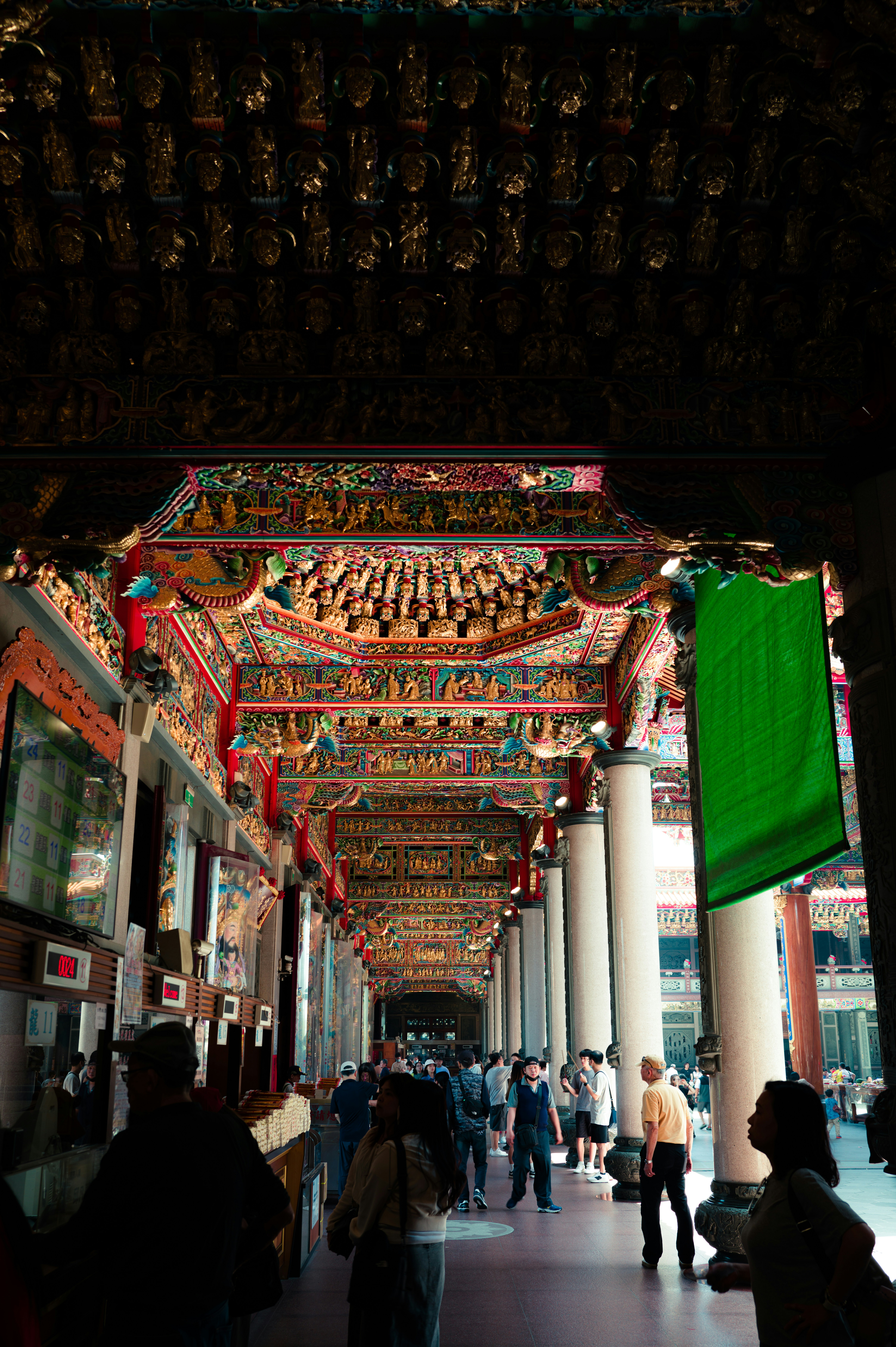 Ornate Corridor of Color: A Crowded Shrine Hall with Painted Ceilings