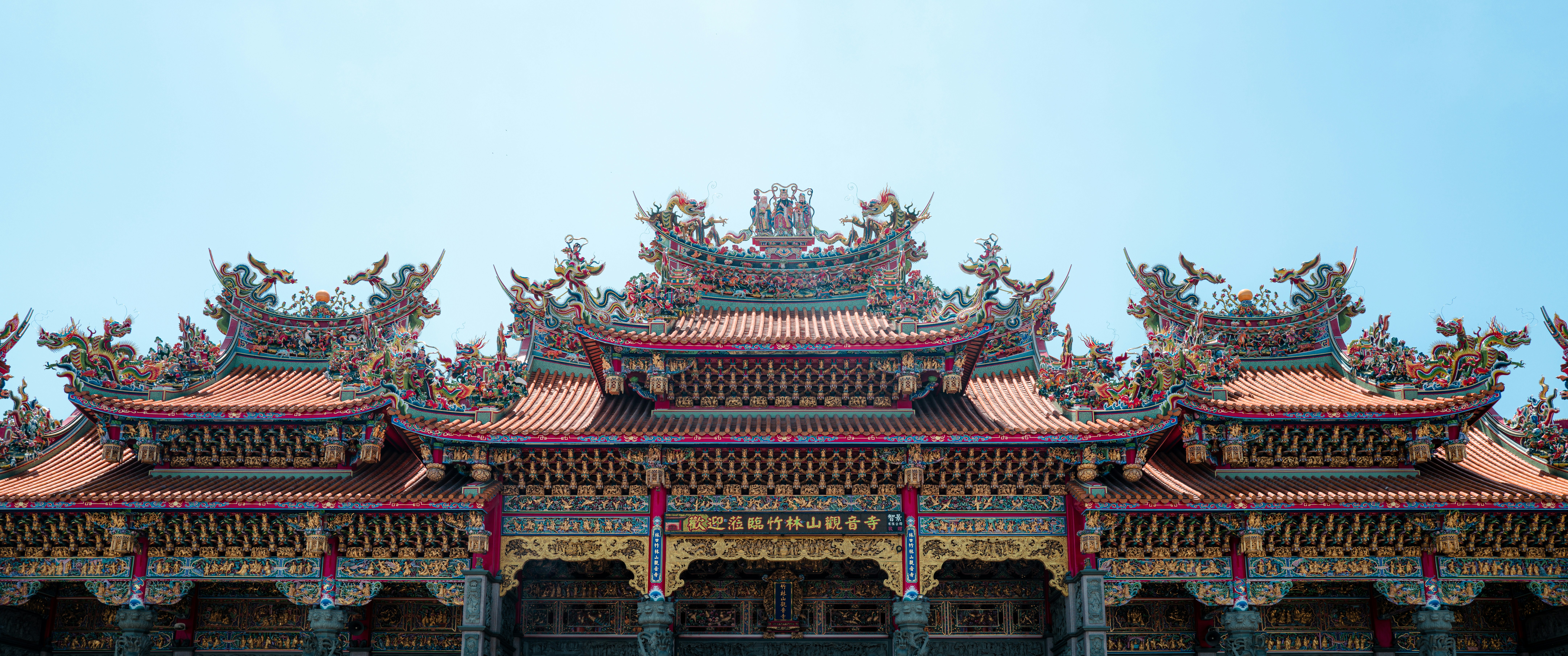 Ornate frontier of temple eaves: a skyline of mythic guardians