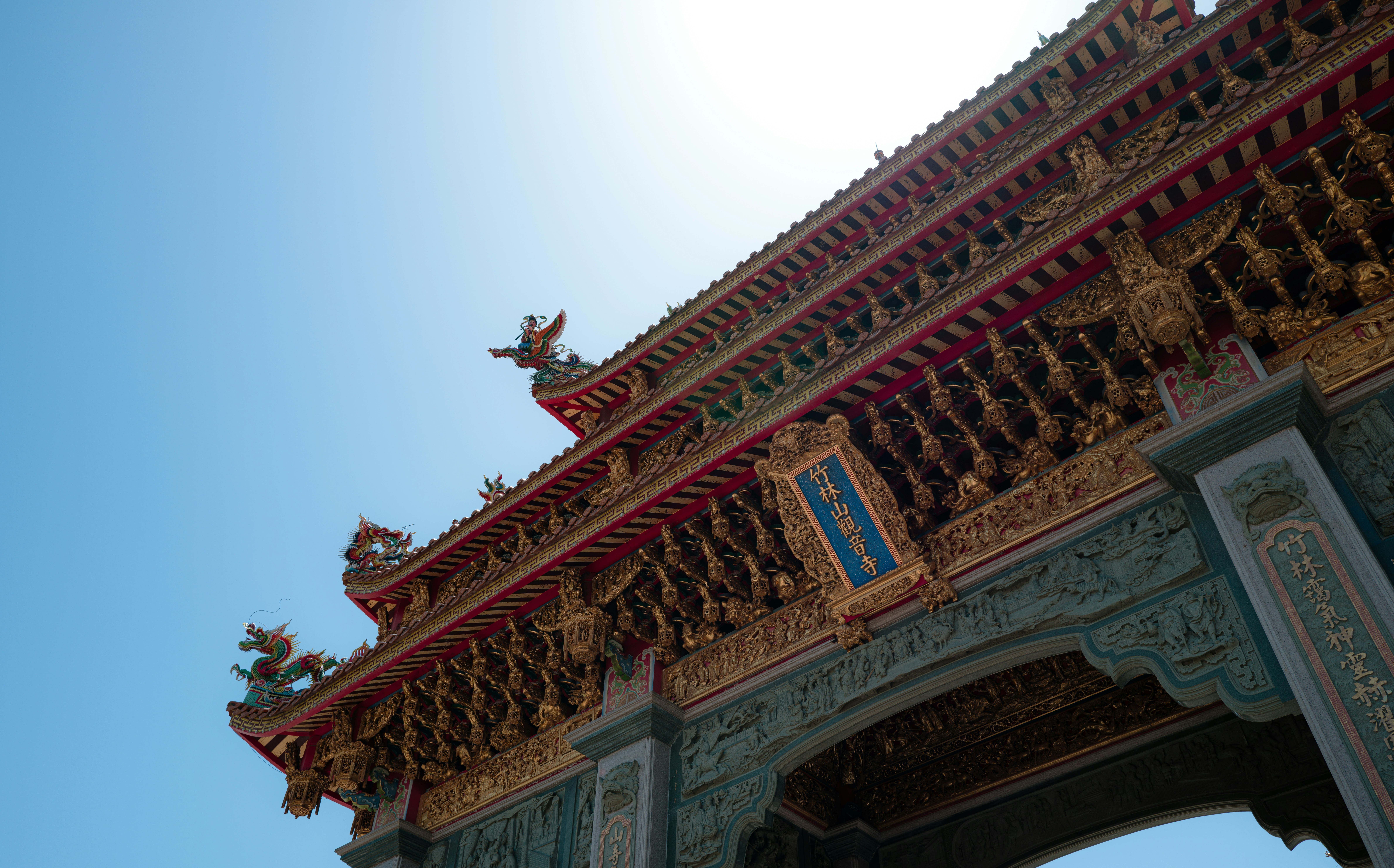 Dragon Crest over the Arch: A Sunlit Facade in Terracotta and Teal