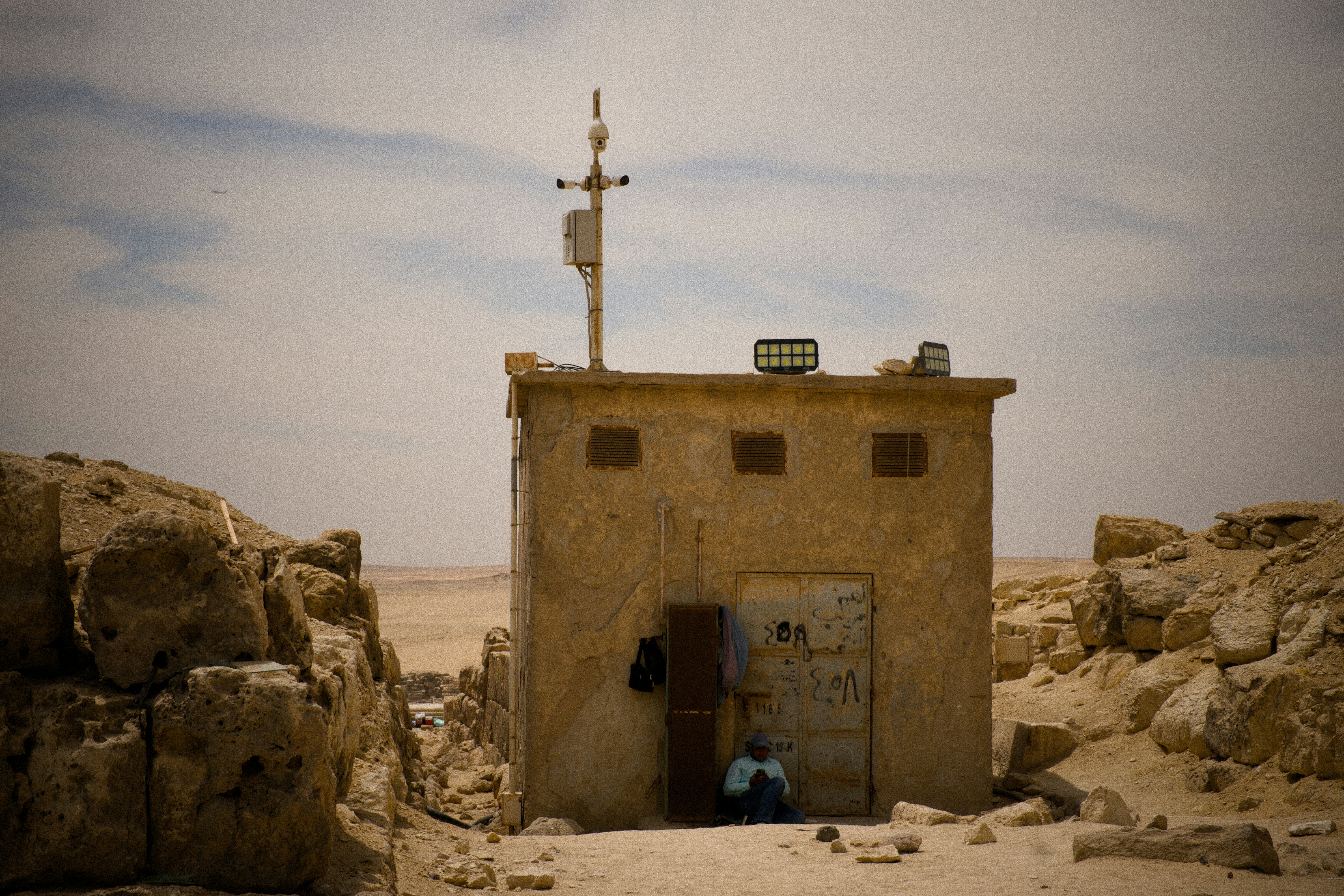 Desert Outpost: A Weathered Signal Hut Amid Rough Terrain