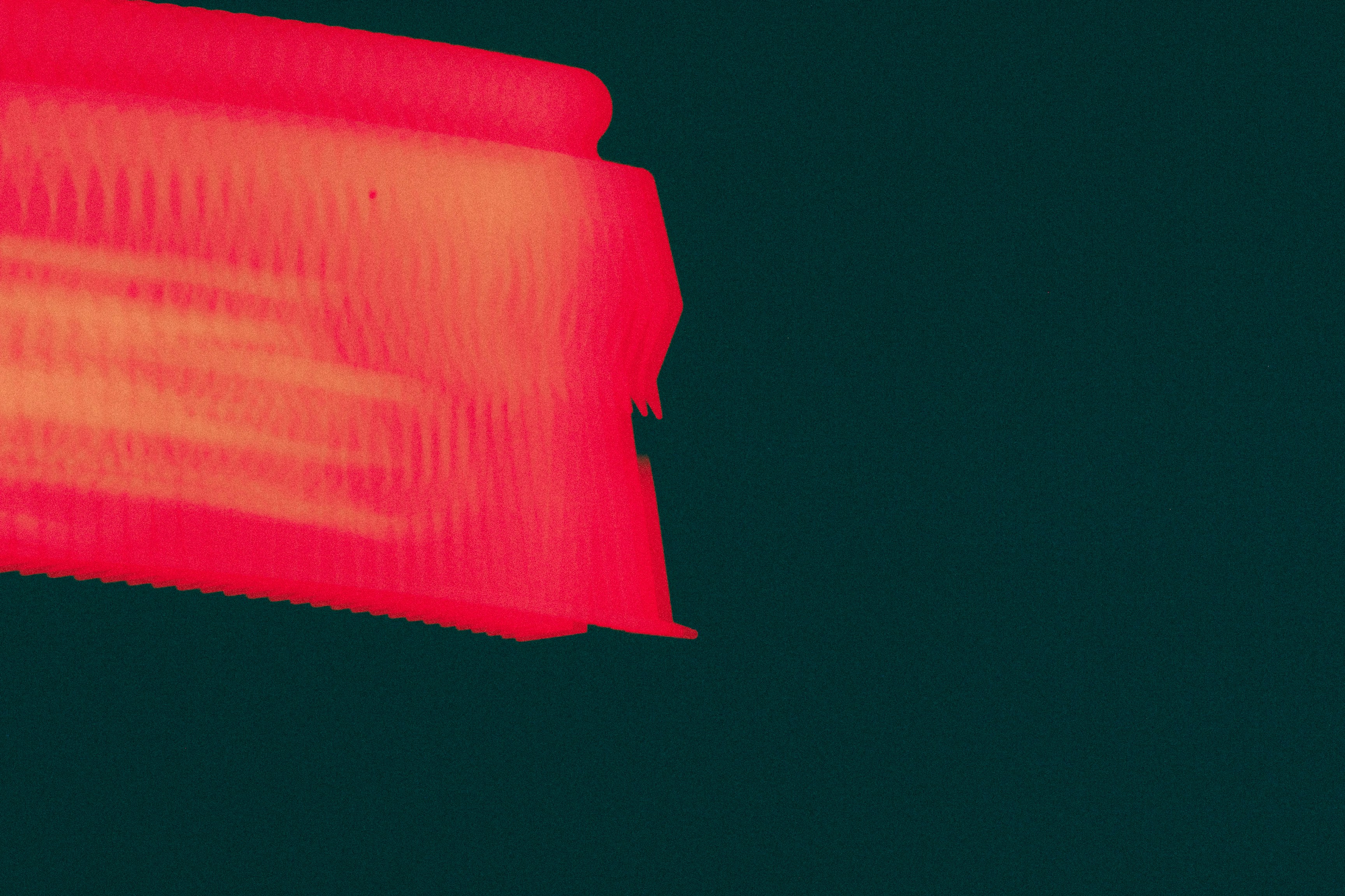 Neon Red Module Drifting in a Deep Green Void
